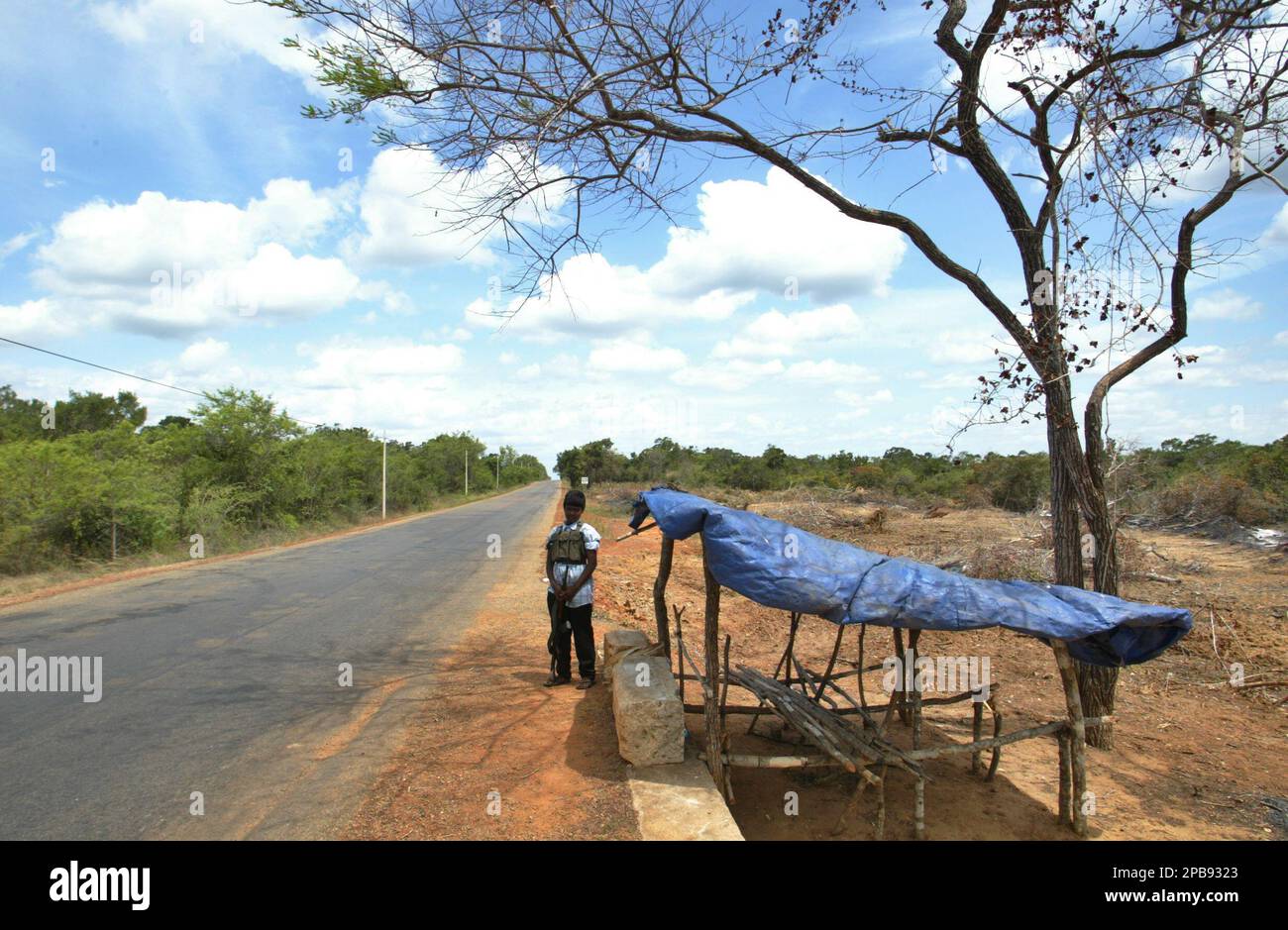 A young female Tamil Tiger fighter stands guard on the main A9 highway ...