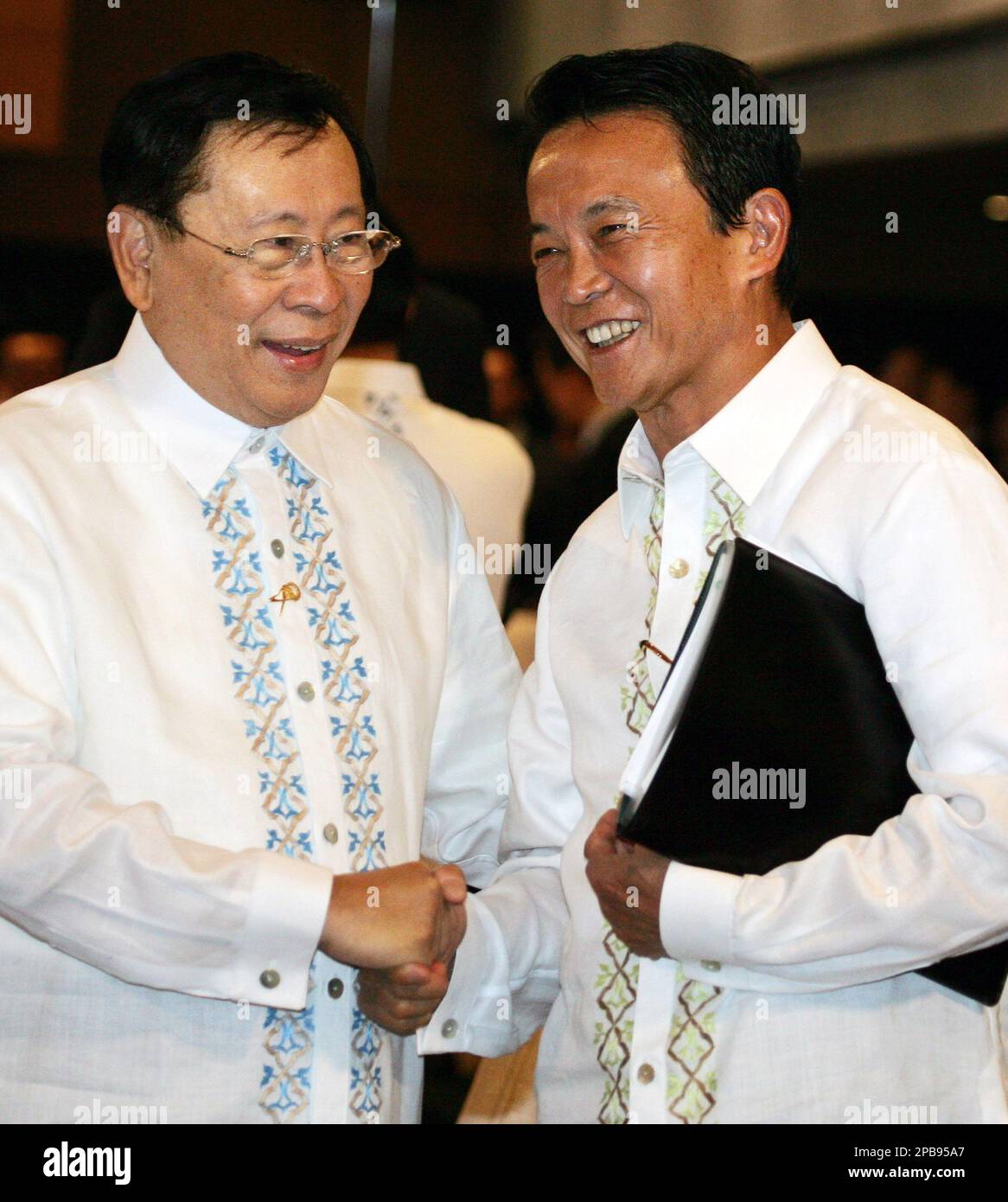 Philippine Foreign Secretary Alberto Romulo, left, greets Japan's ...