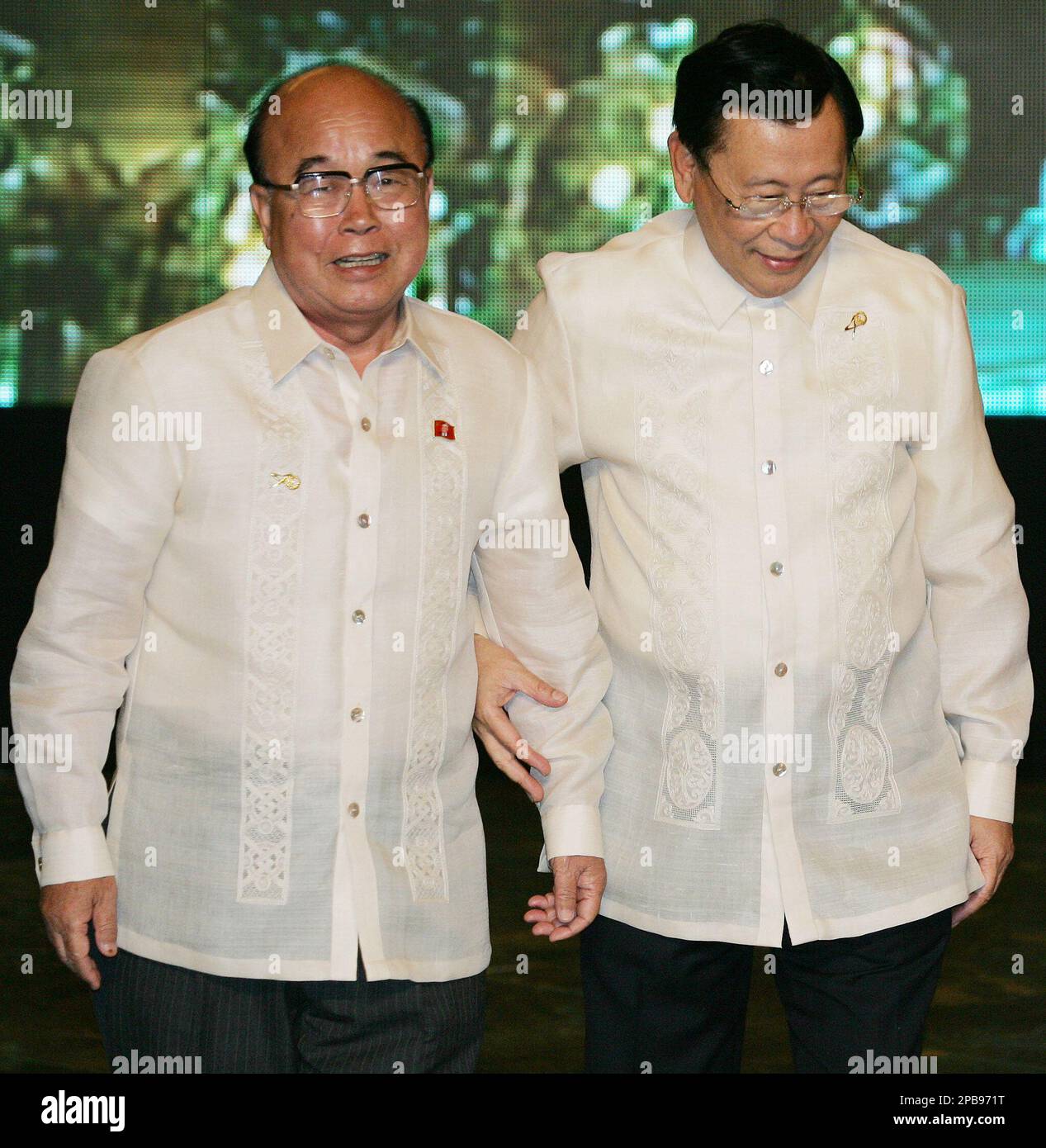 North Korea's Foreign Minister Pak Ui Chun, left, is assisted by ...