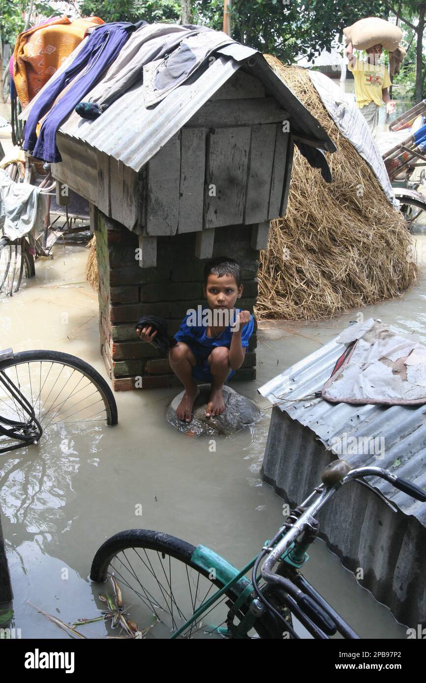 A young flood victim looks on as she sits at a shelter center at a ...