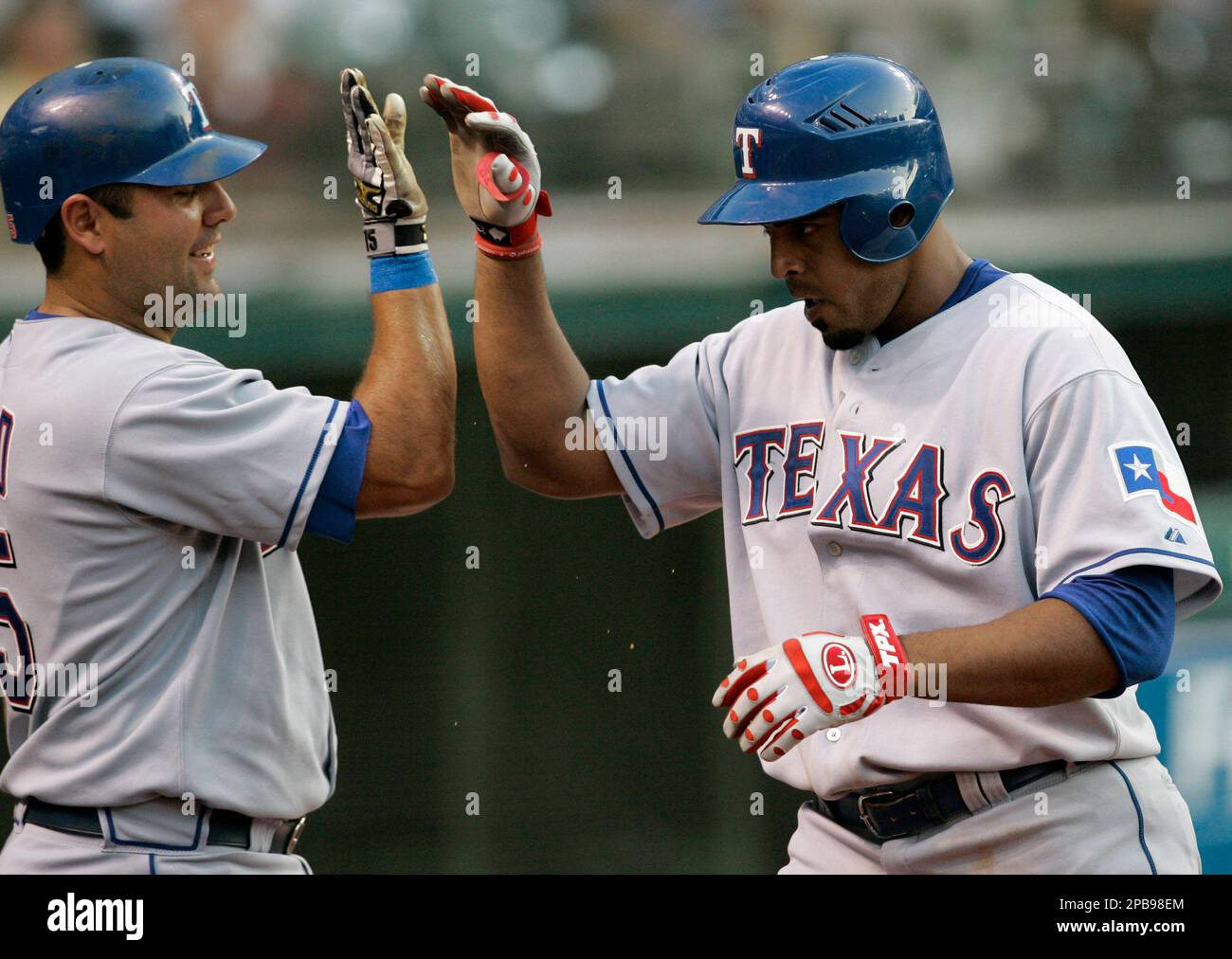 Texas Rangers' Gerald Laird, left, congratulates Nelson Cruz after Cruz ...