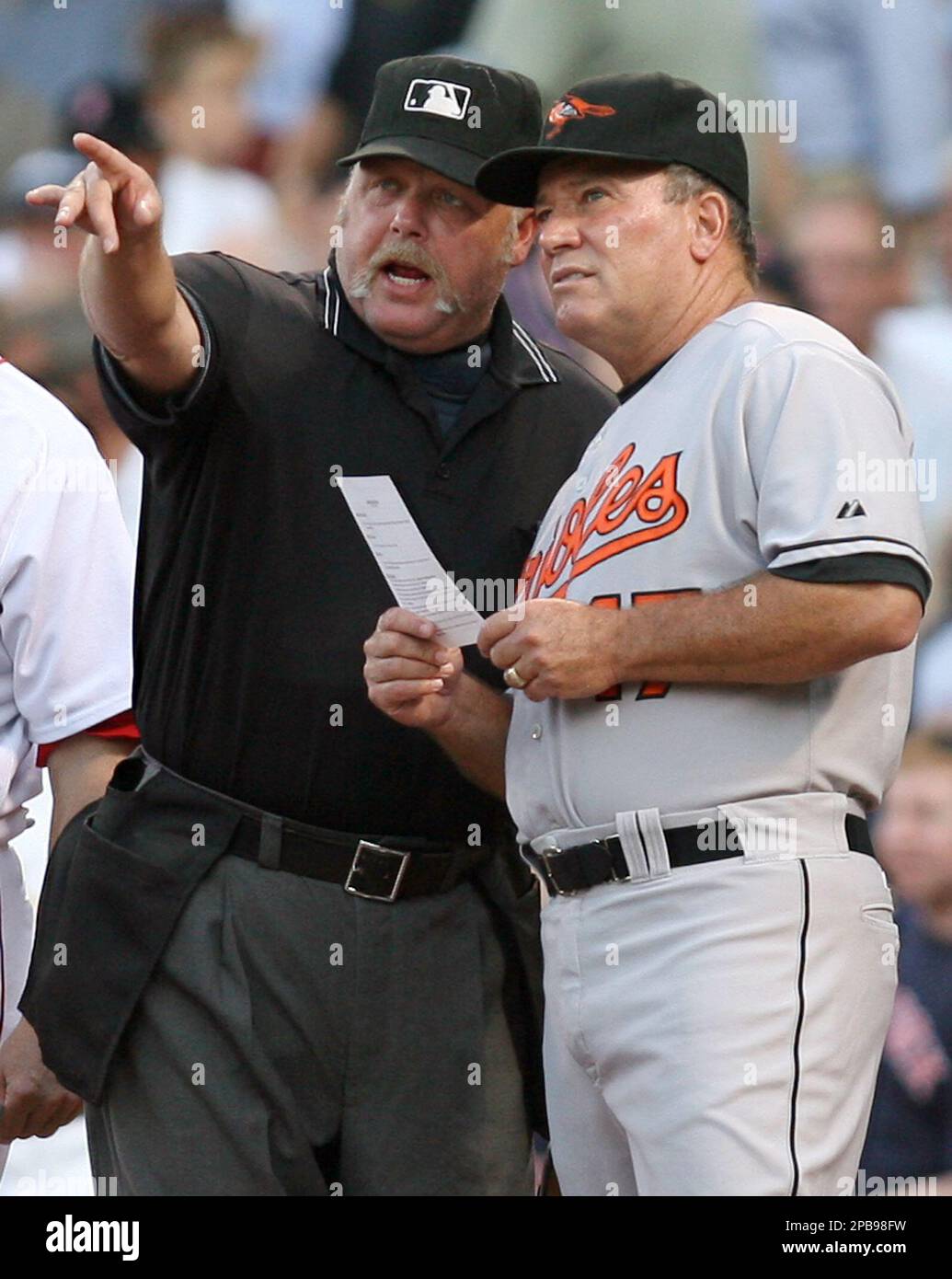 Baltimore Orioles manager Dave Trembley, right, talks with umpire Jim ...