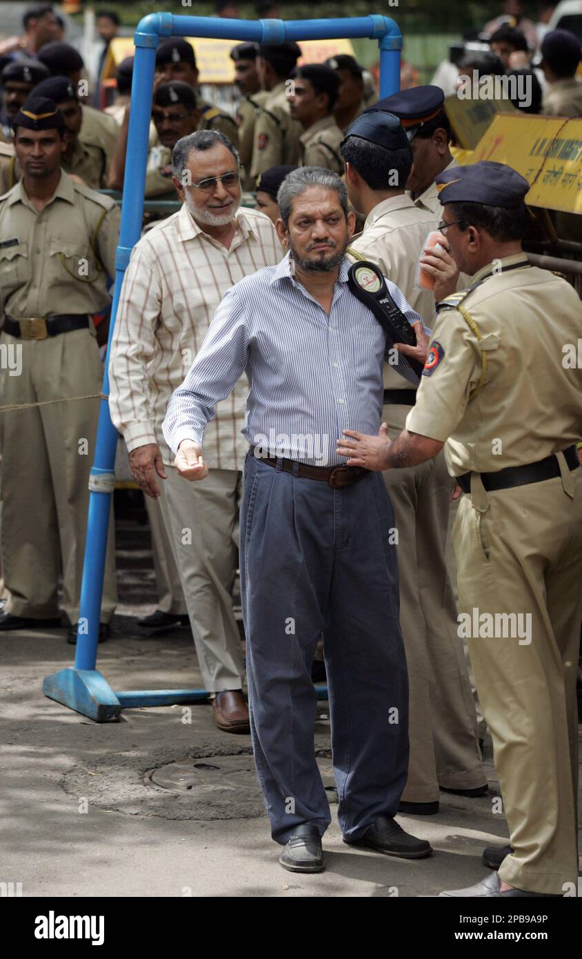 Yusuf Nulwala, center right, is frisked by a policeman as Rusi Mulla ...