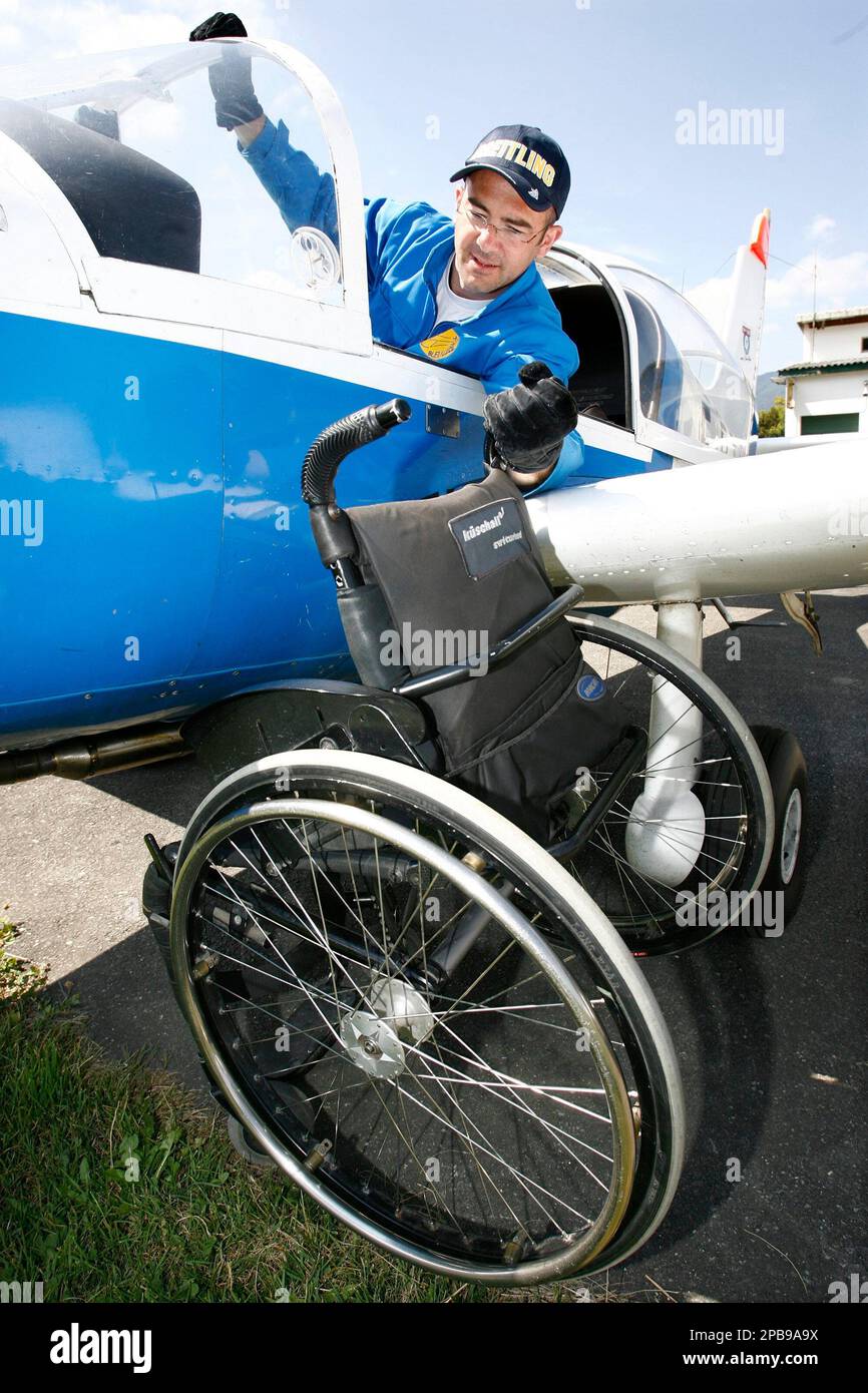 French handicaped pilot Philippe Carette stores his wheelchair in his ...