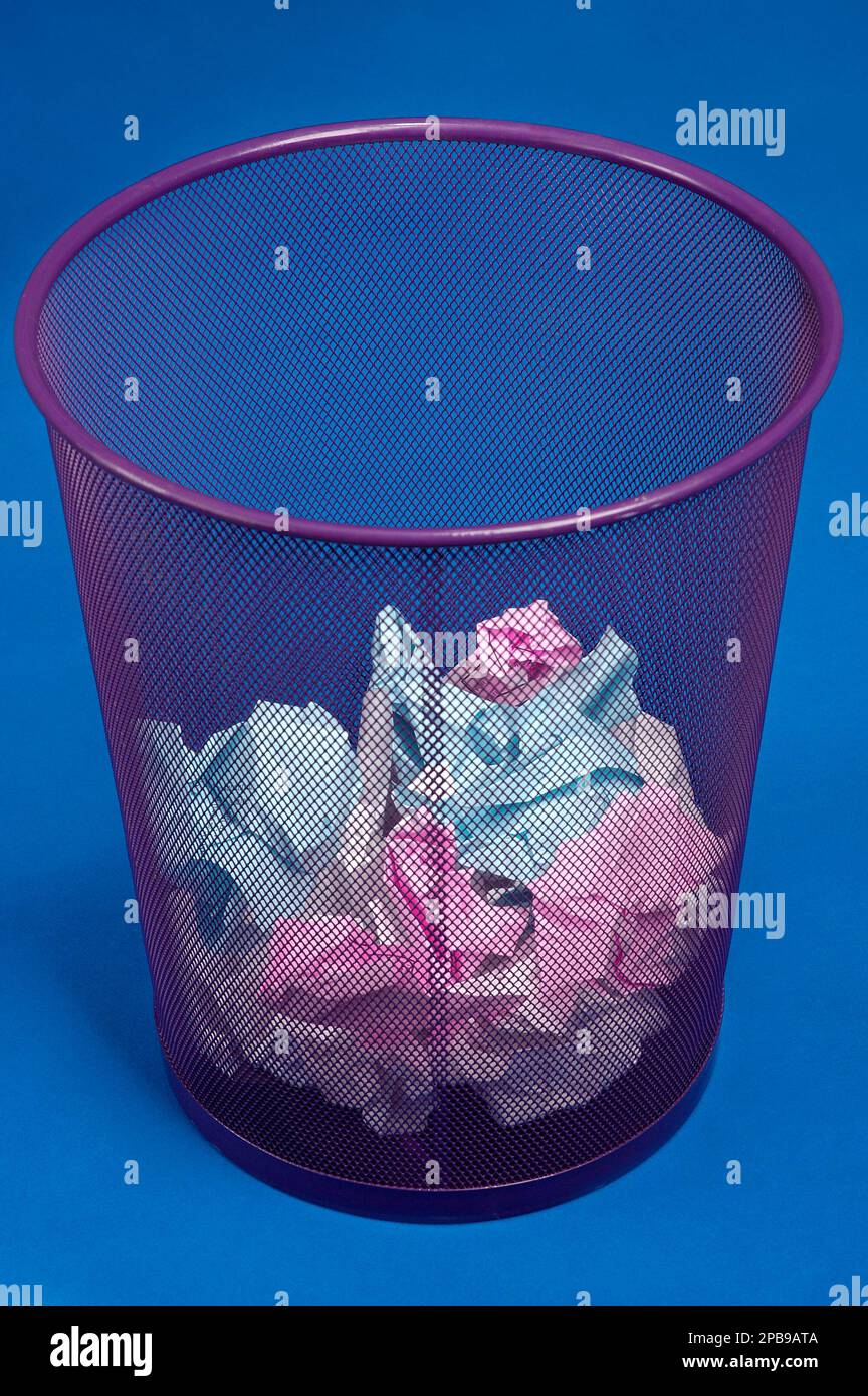 A trash can or rubbish bin containing crumpled paper Stock Photo - Alamy