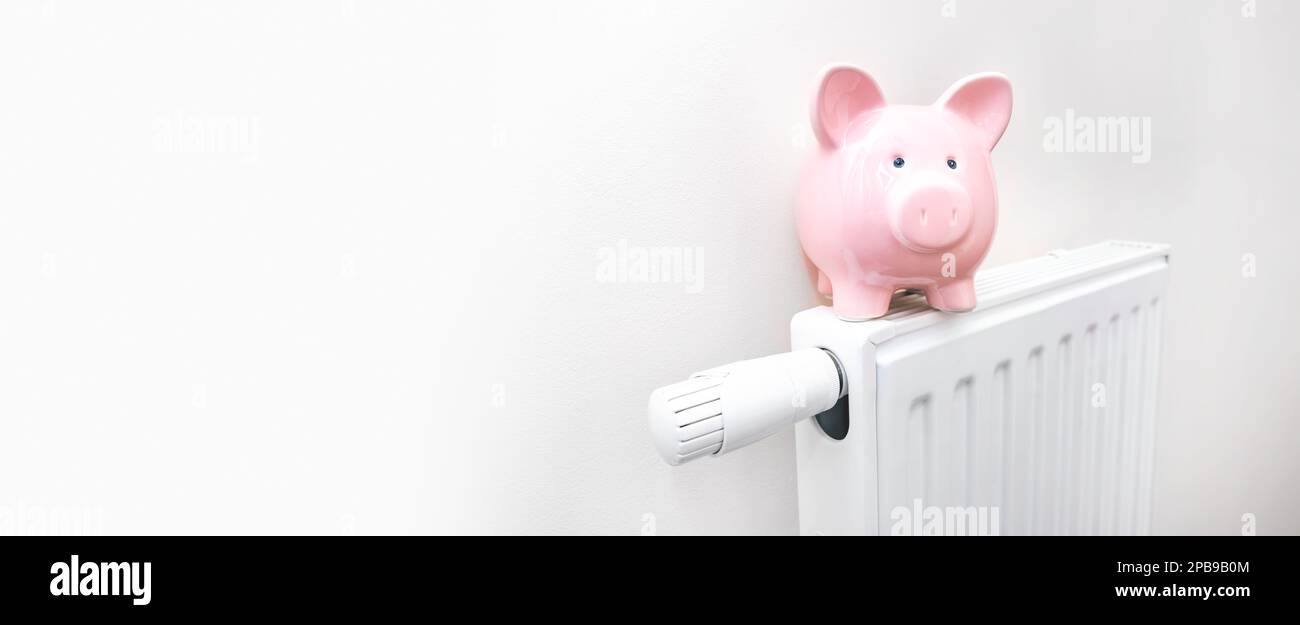 Radiator at home, the concept of rising heating prices. Piggy bank with ...