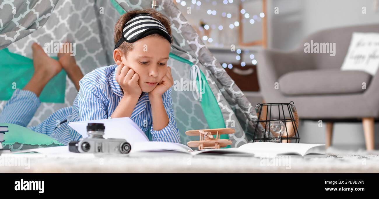 Smart little boy reading book at home Stock Photo - Alamy