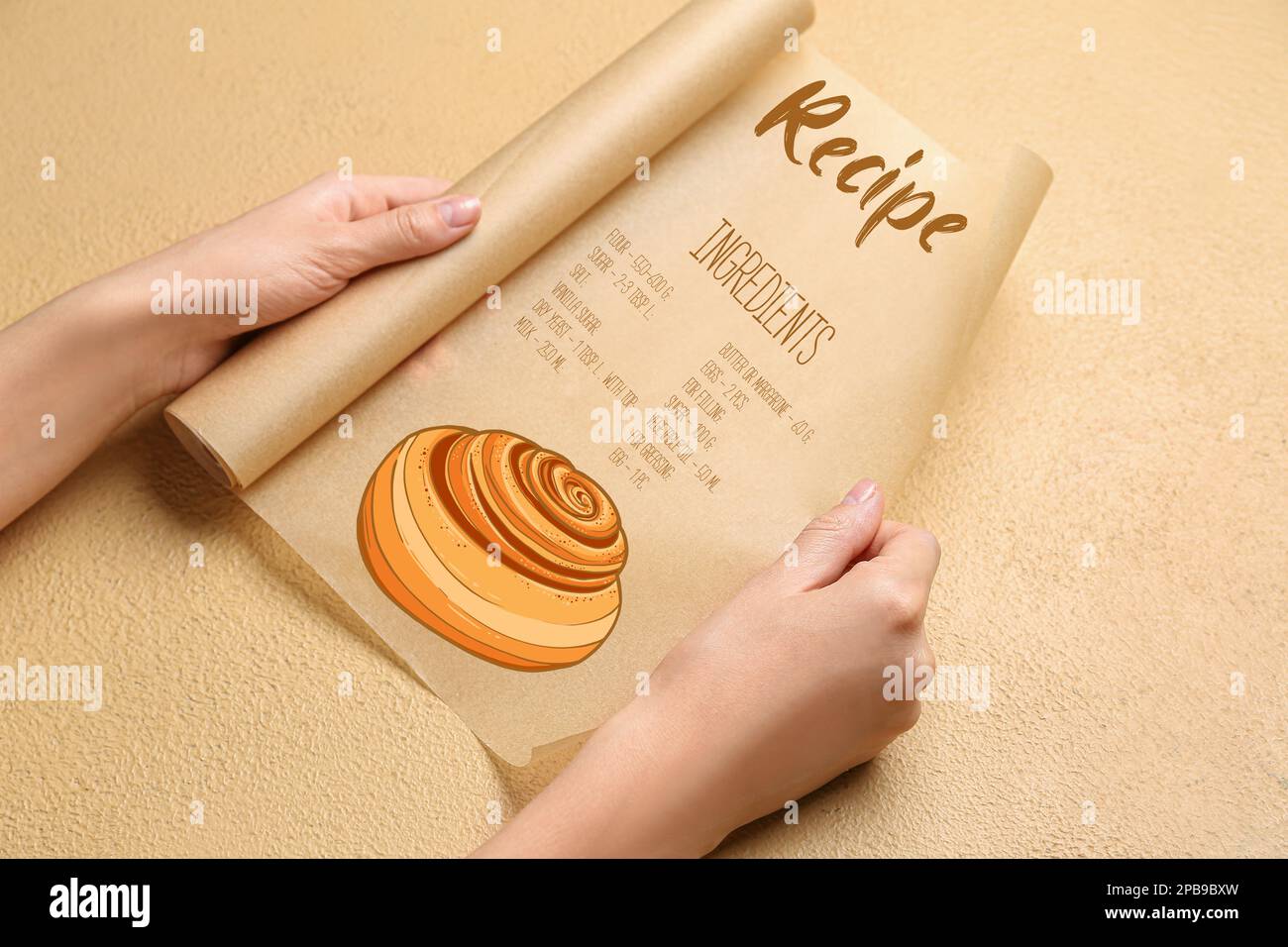 Female hands holding baking paper with written recipe on beige ...