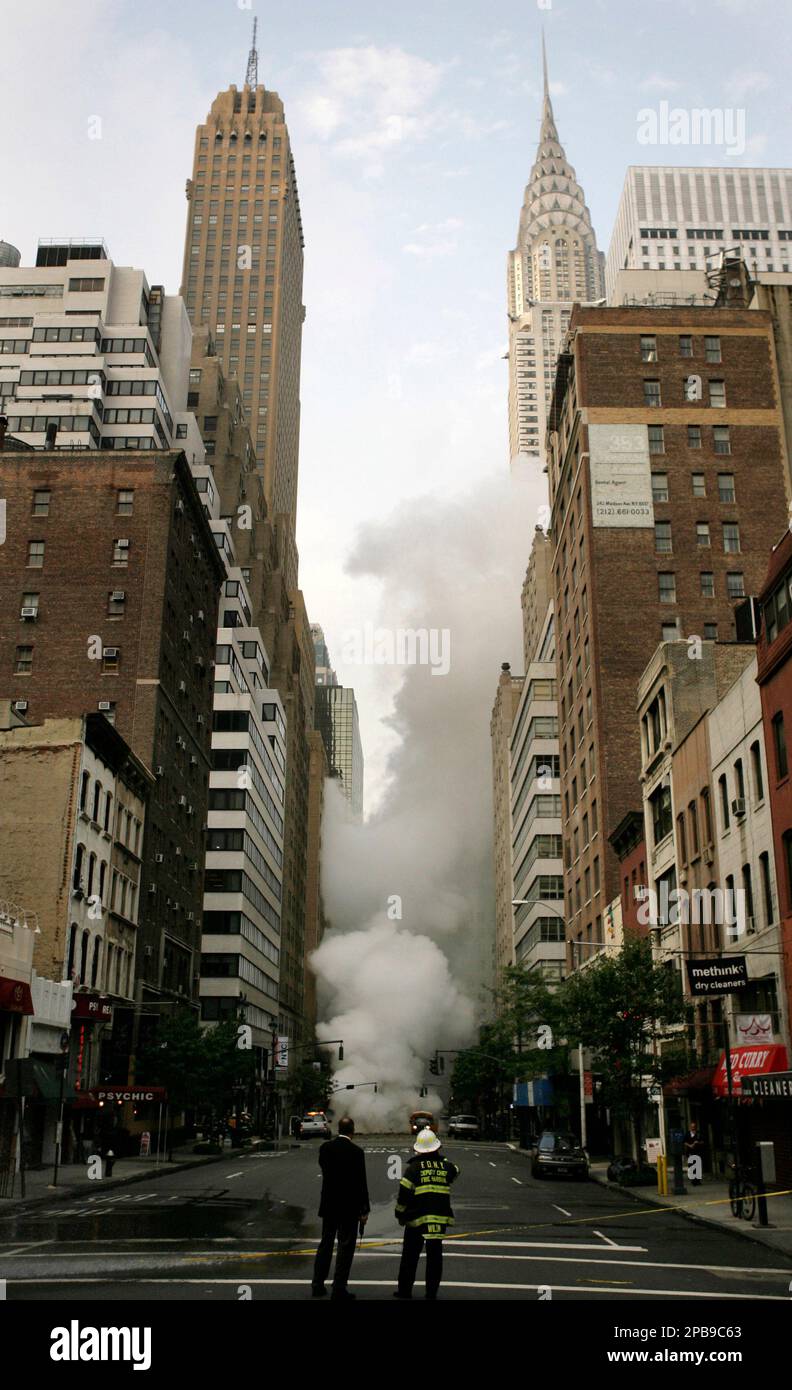 ** FILE ** Emergency personnel survey the scene of a steam explosion in ...