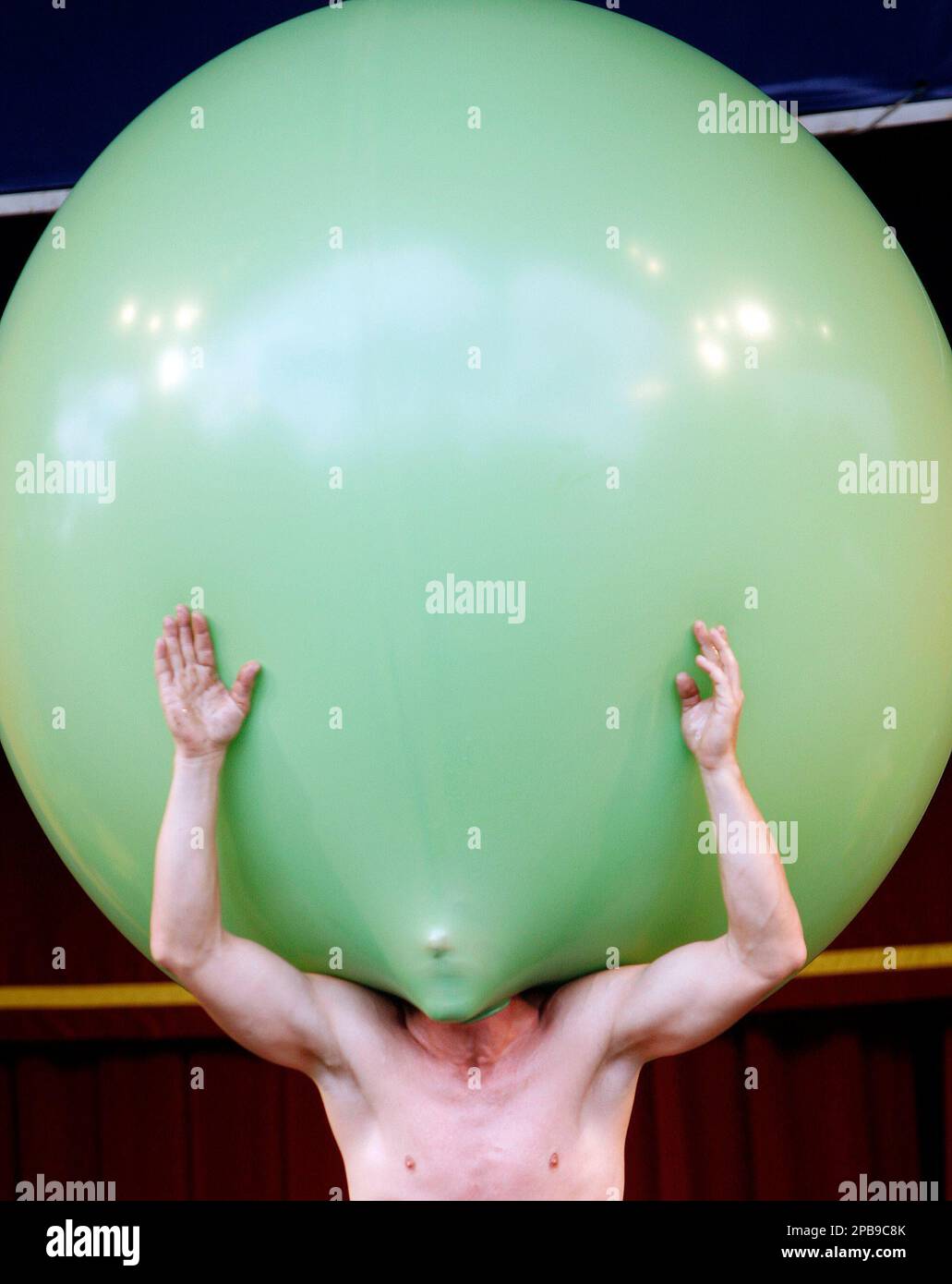 Mr. Toons performs with an enormous balloon on his head during the ...