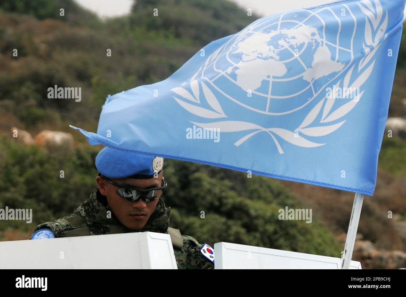 A South Korean U.N peacekeeper sits in an armored vehicle as he watches ...