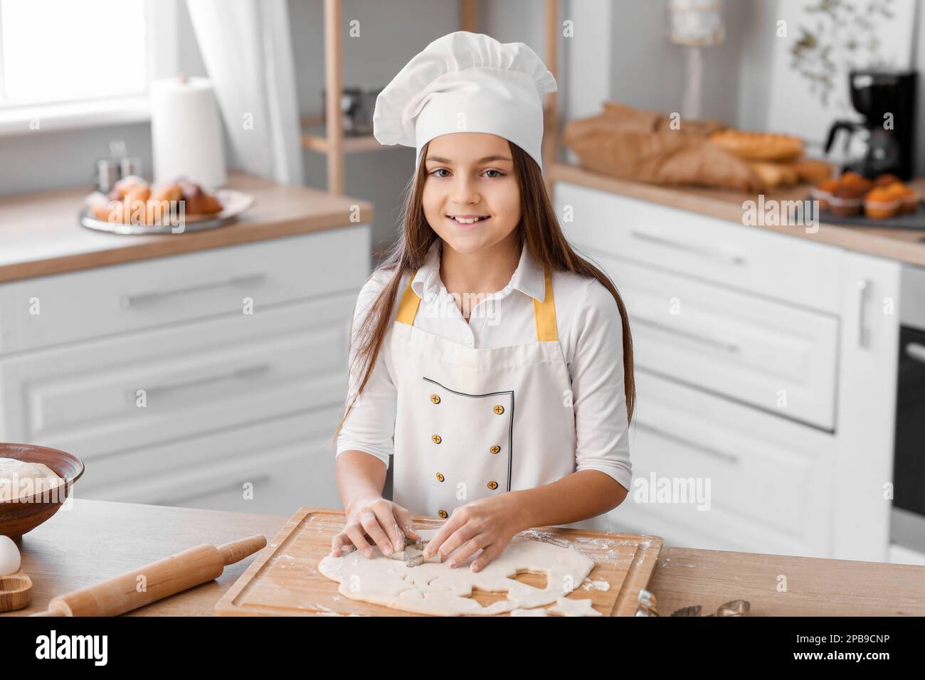 Little baker cutting dough for cookies in kitchen Stock Photo - Alamy