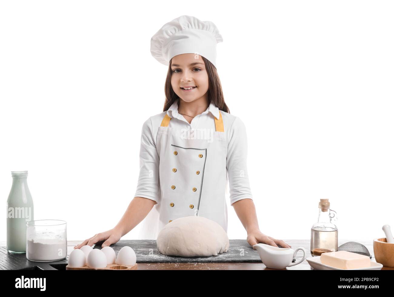 Little baker at table with dough on white background Stock Photo - Alamy