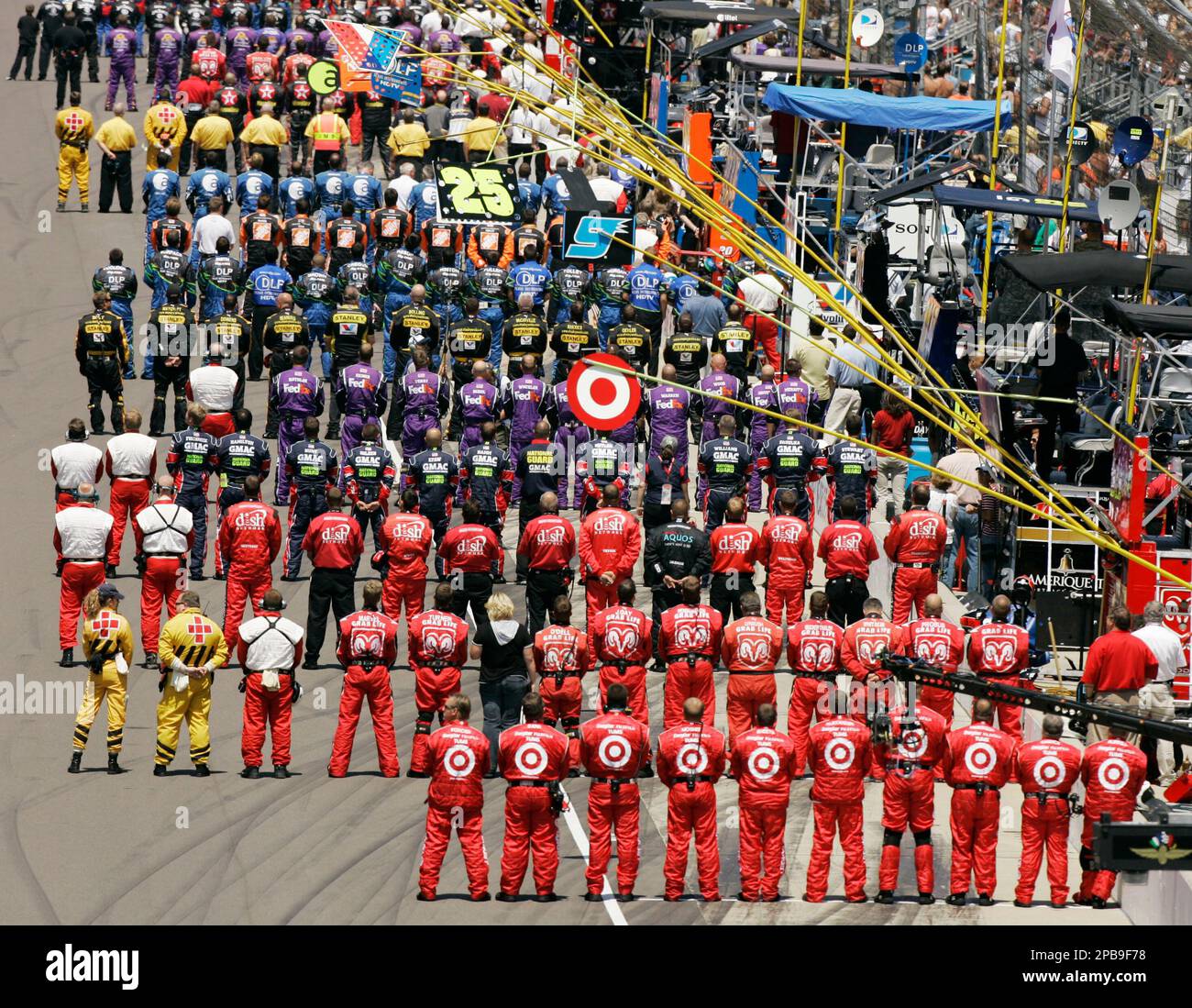 Crew members line up for the national anthem before the start of the ...