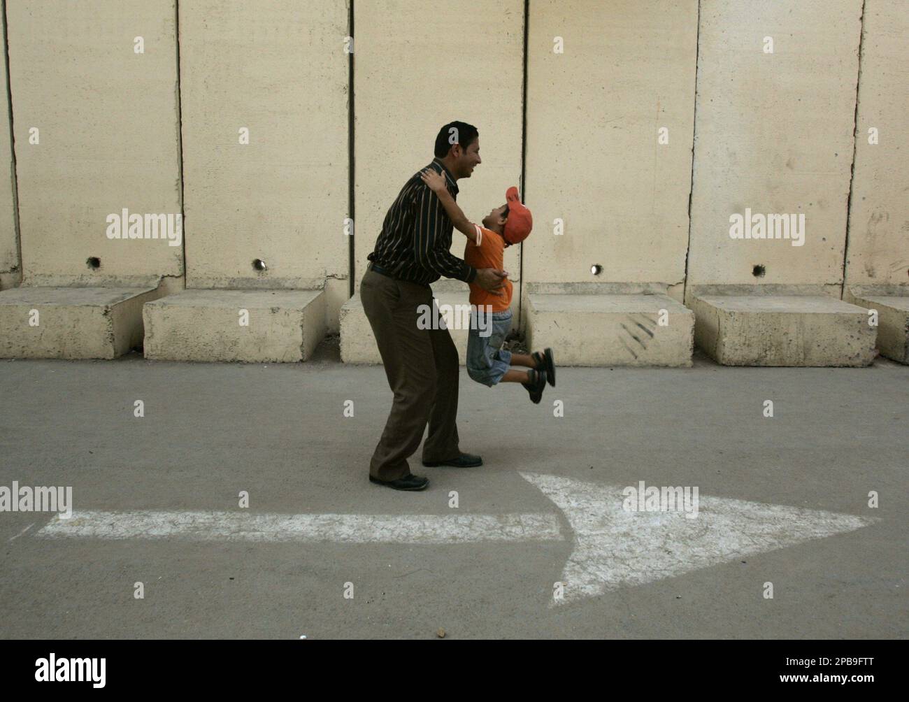 A Palestinian child jumps on his father as he returns to Gaza Strip ...