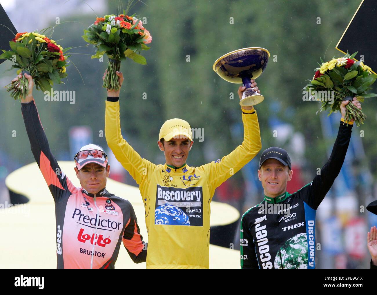 2007 Tour de France's winner Alberto Contador of Spain, center, waves ...