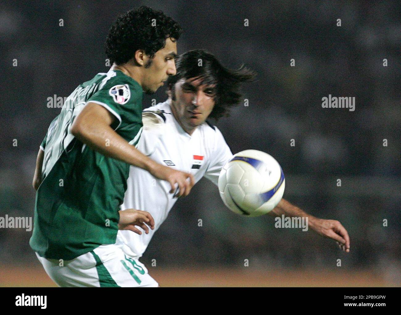 Saudi Arabia's Abdulrahman Al Qahtani, left, fights for the ball with ...