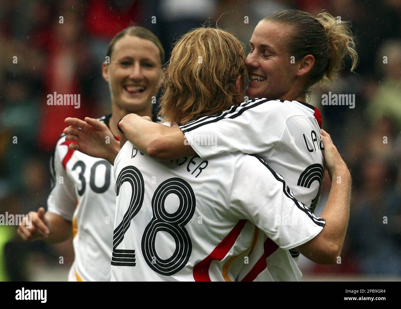 Melanie Behringer of Germany, center, celebrates with Simone Laudehr ...