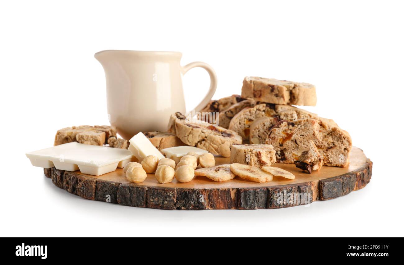 Board with delicious biscotti cookies, nuts, chocolate and pitcher ...