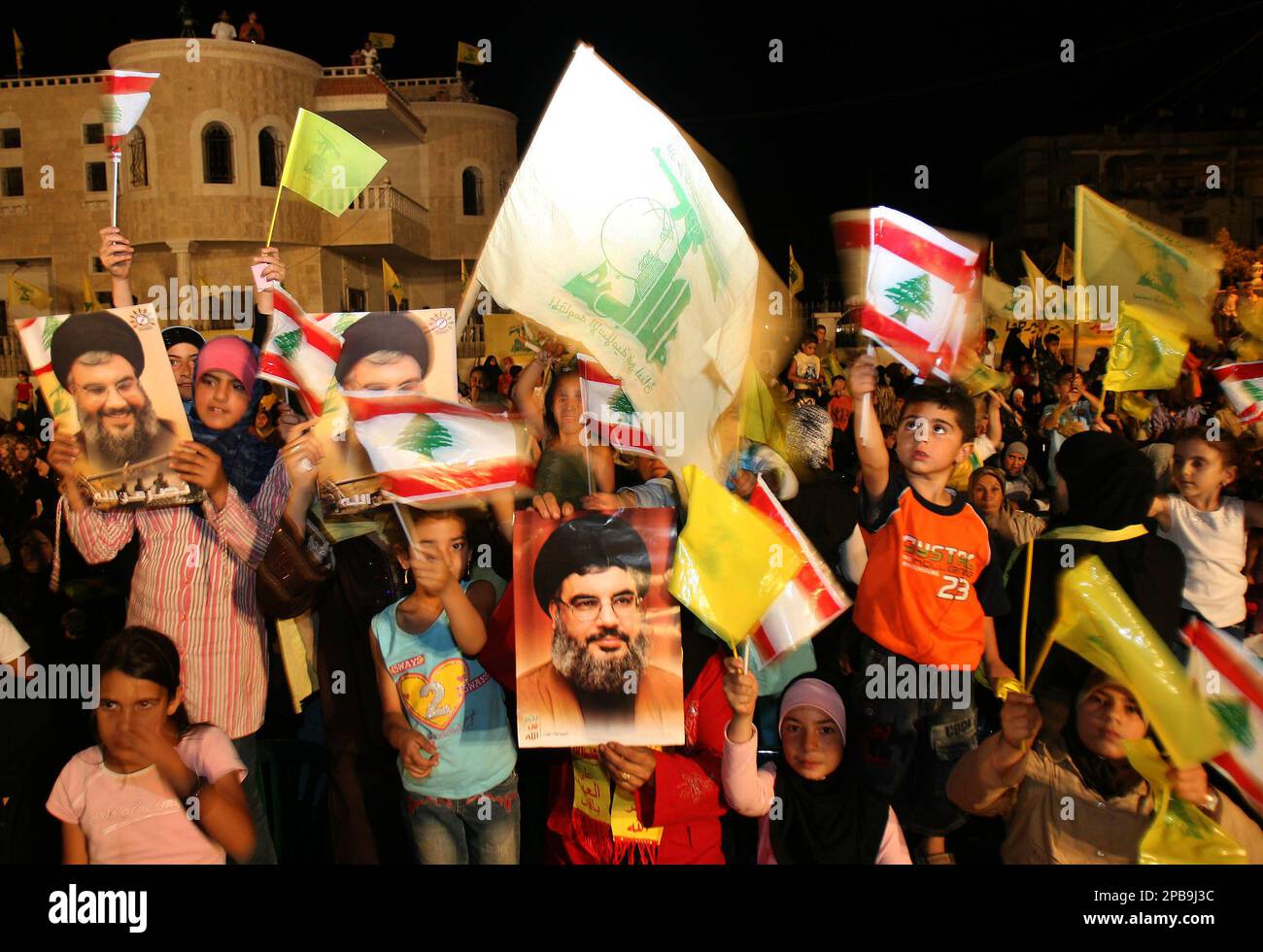 Lebanese Hezbollah supporters, wave Lebanese and Hezbollah flags ...
