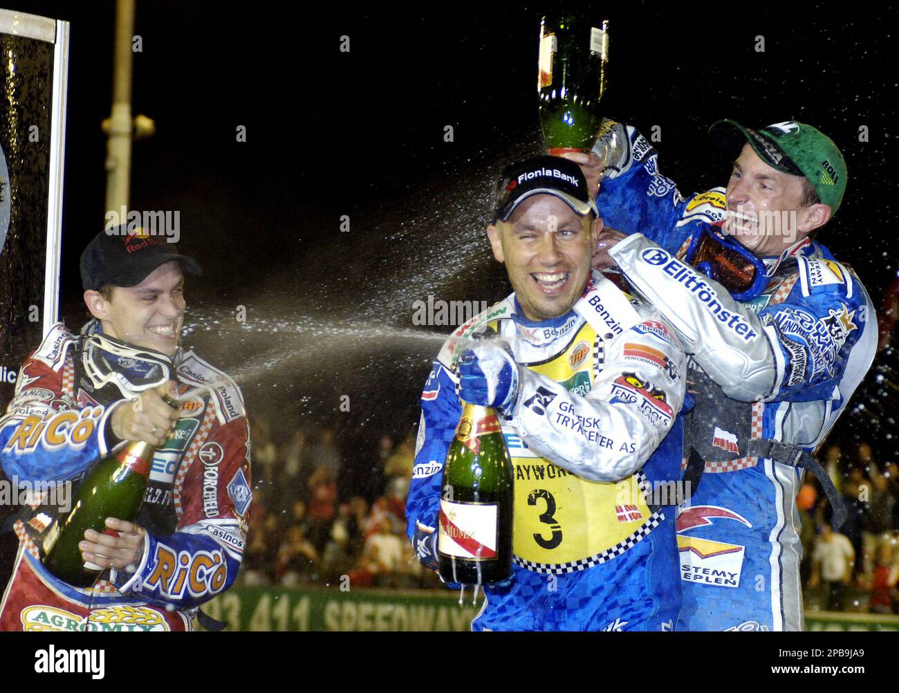 Niki Pedersen of Denmark, center, celebrates his winning on the podium ...