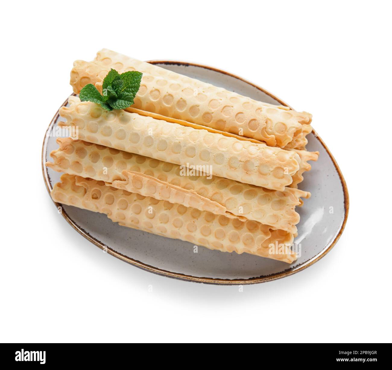 Plate with stack of delicious wafer rolls and mint isolated on white ...