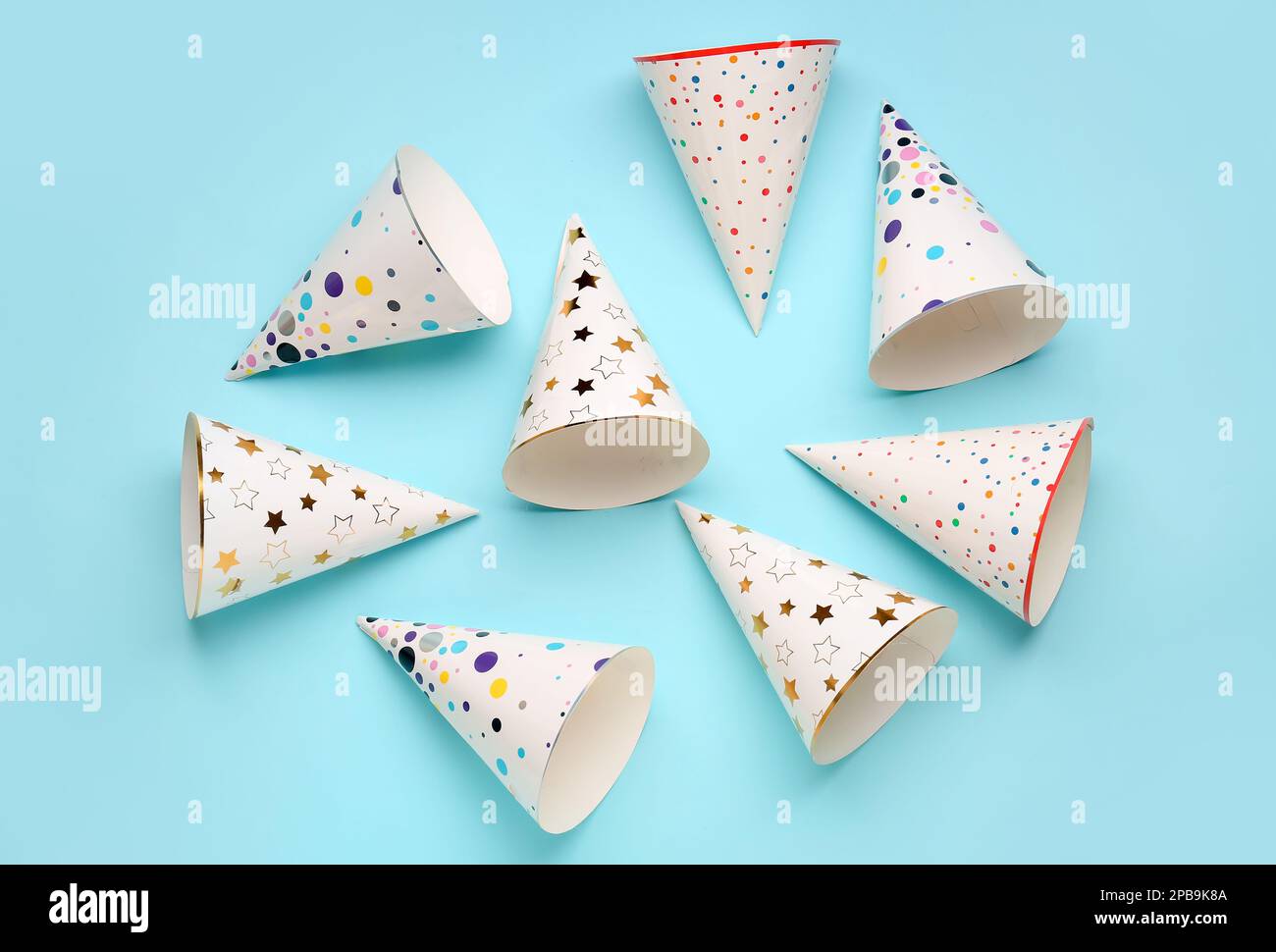 Set of different party hats on color background Stock Photo - Alamy