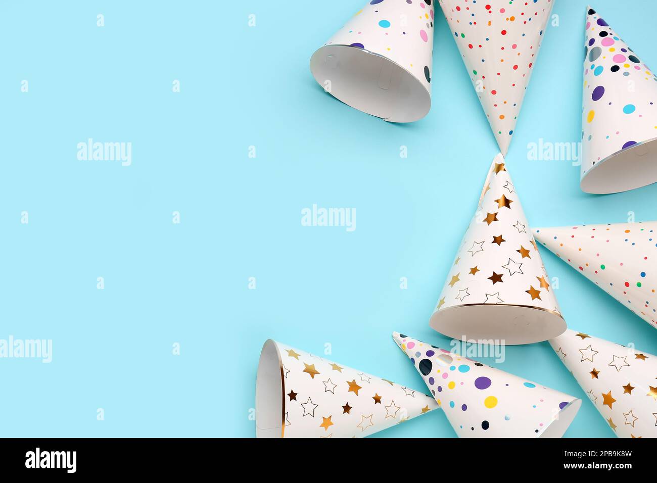Set of different party hats on color background Stock Photo - Alamy
