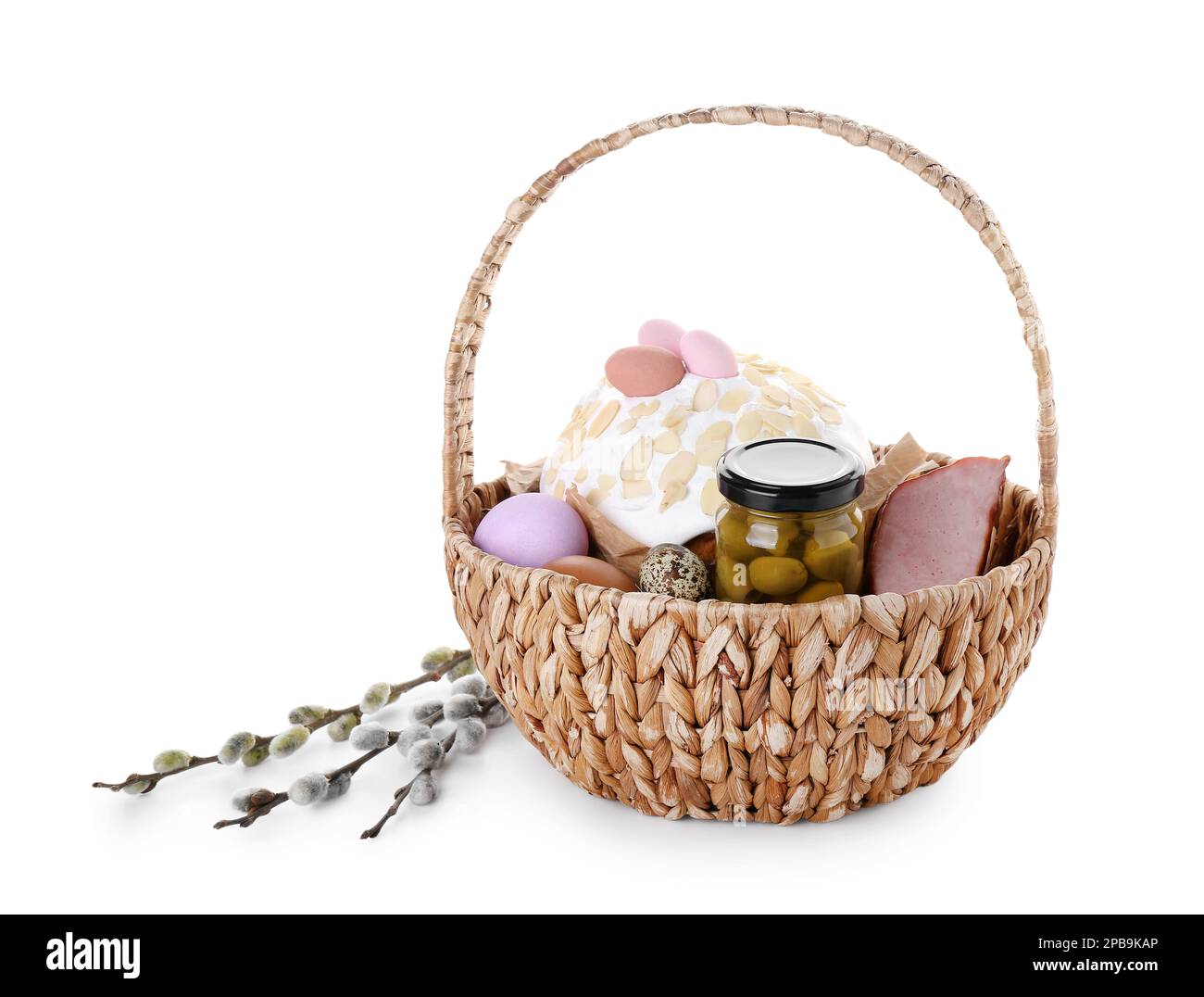 Basket with Easter eggs, cake, jar of olives and ham isolated on white ...