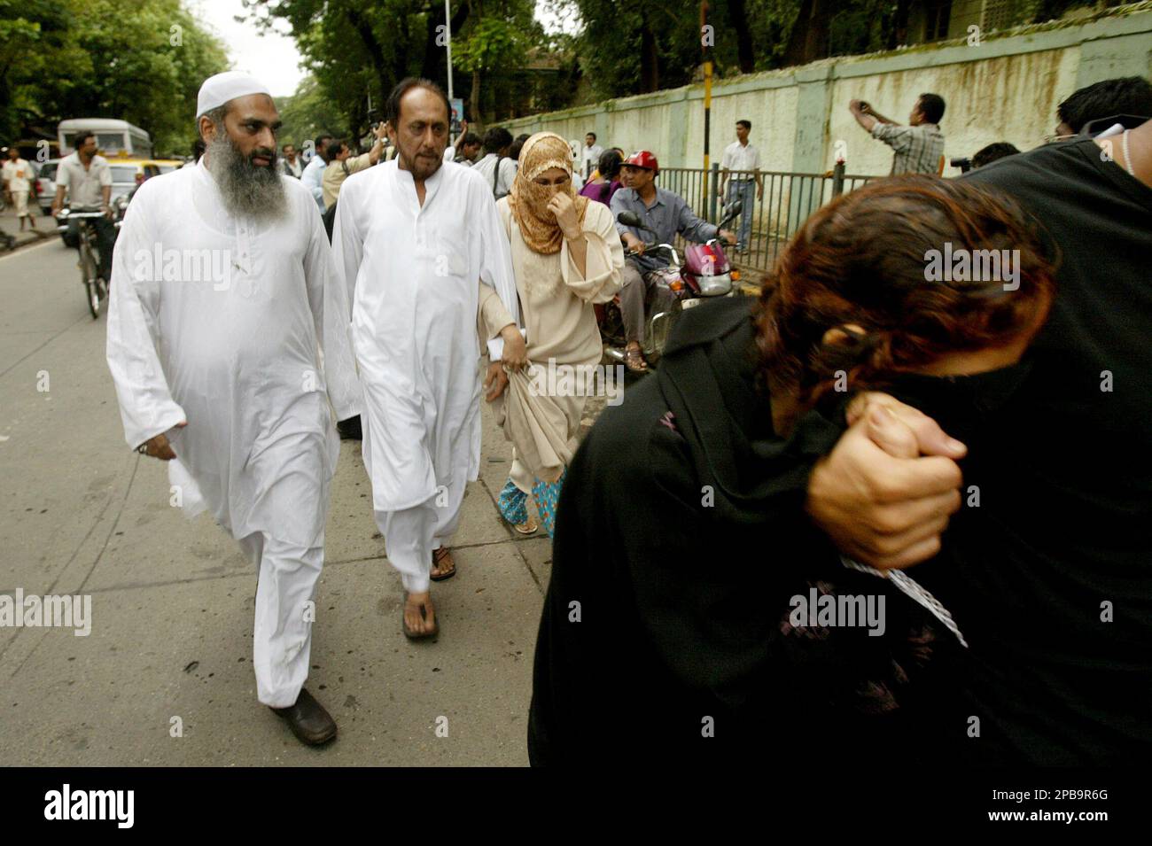 Raheen Memon, center in beige dress, wife of Yakub Memon, and other ...