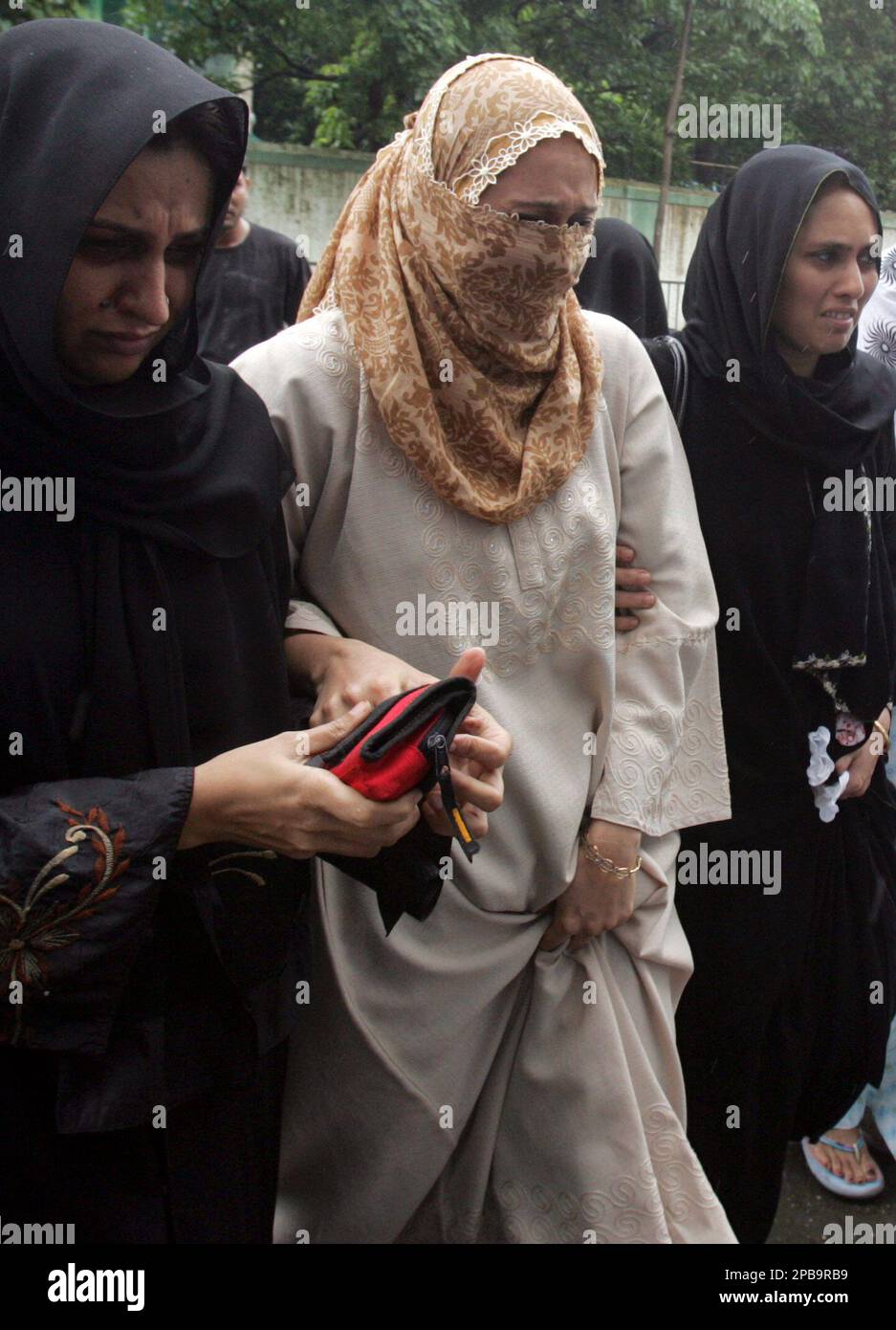 Raheen Memon, center, wife of Yakub Memon, reacts as she arrives at a ...