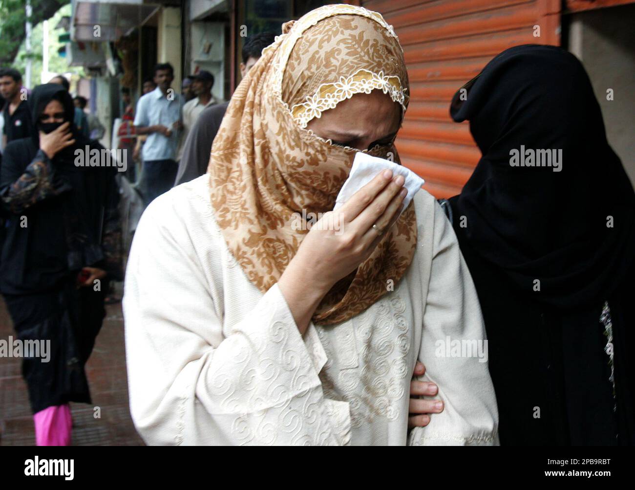 Raheen Memon, center, wife of Yakub Memon, reacts as she arrives at a ...