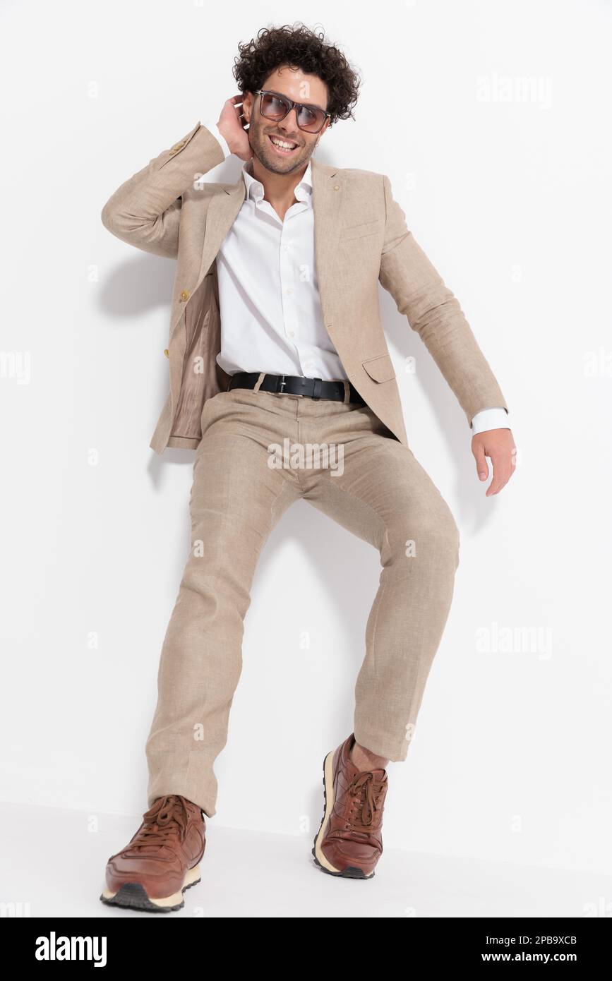 happy man in casual outfit holding hand behind neck and laughing in ...