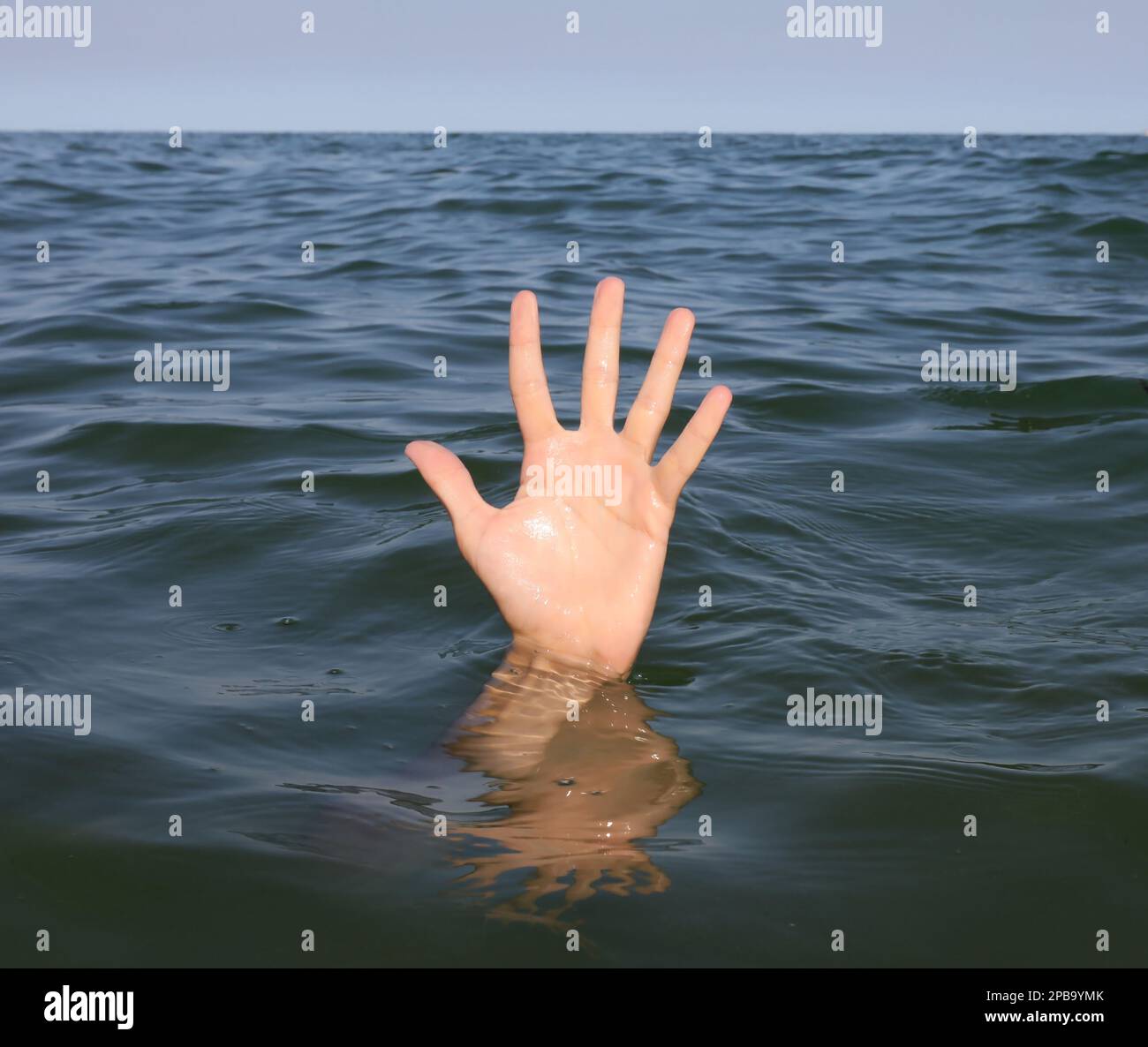 hand of the person asking for help while in danger of drowning in the ...