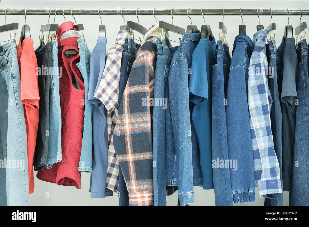 Fashion clothes on clothing rack Closeup of rainbow color choice female ...