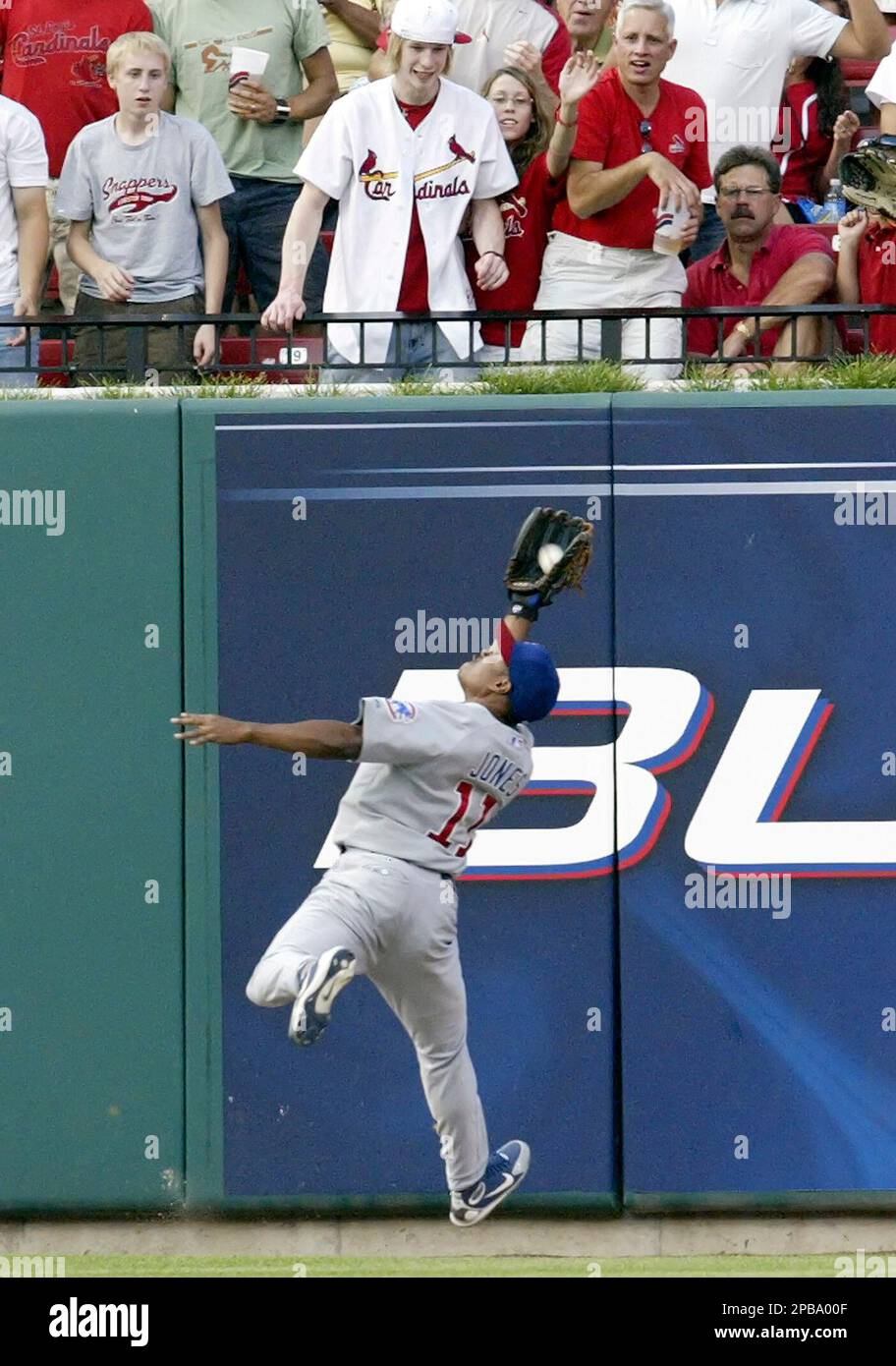 Chicago Cubs center fielder Jacque Jones catches a deep fly ball hit by ...
