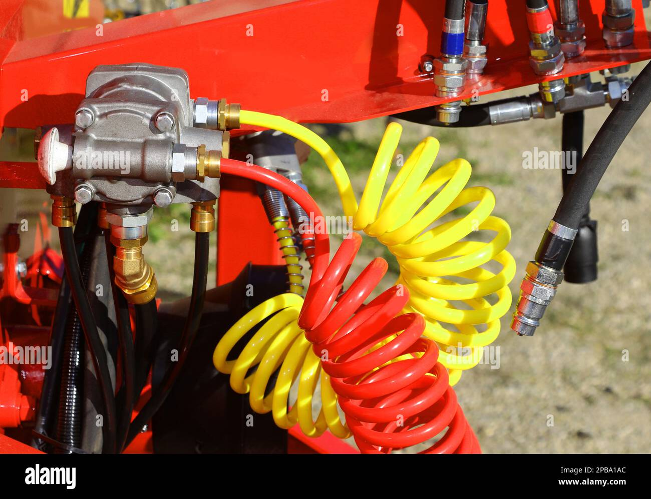 red and yellow tubes of compressed air and the oleodynamic system of an ...