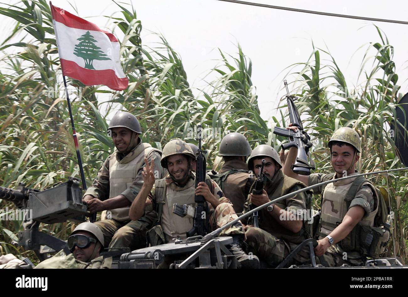 Lebanese army soldiers sit on their armored personnel carrier (APC) on ...