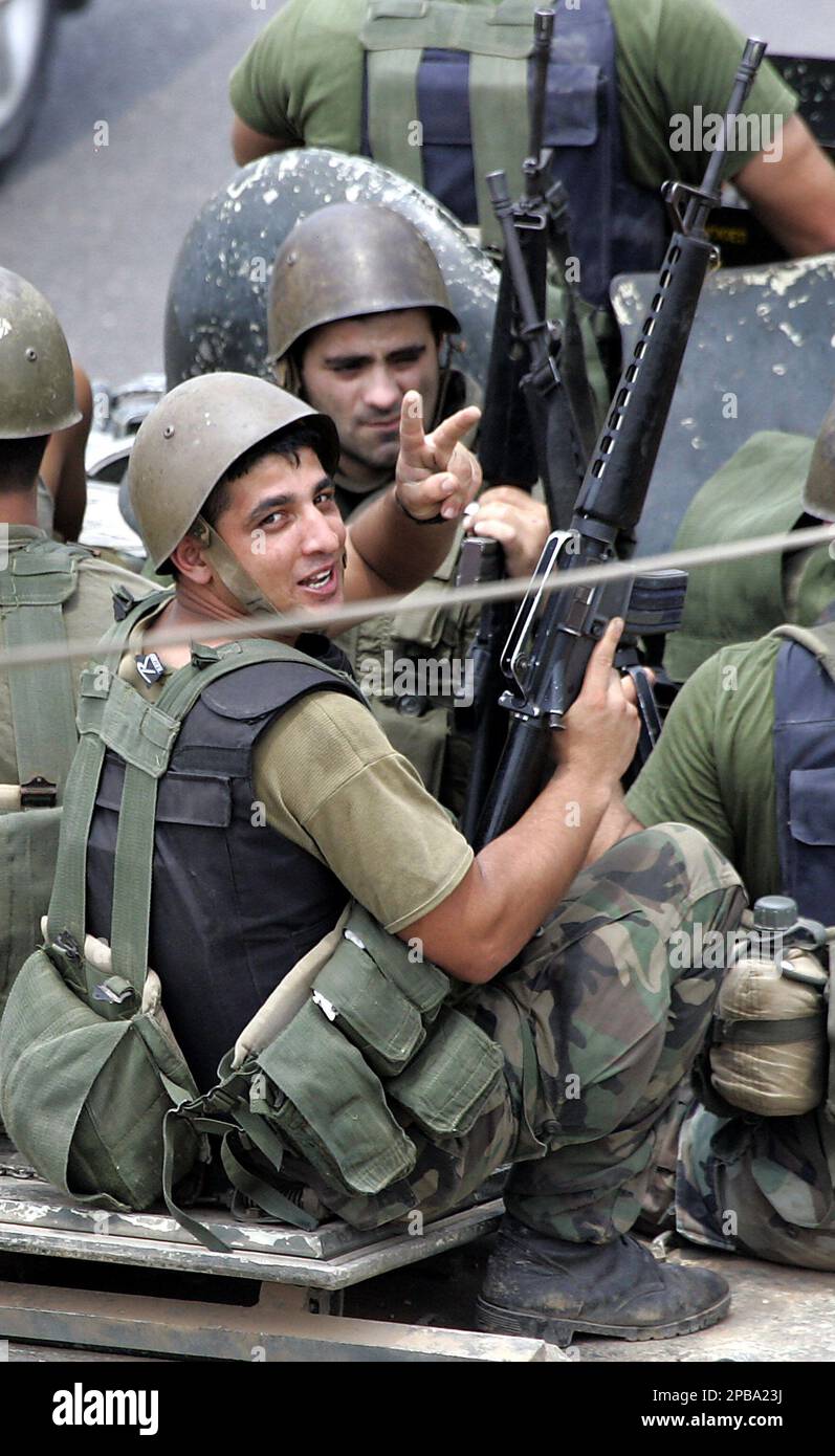 A Lebanese army soldier sitting on his armored personnel carrier (APC ...