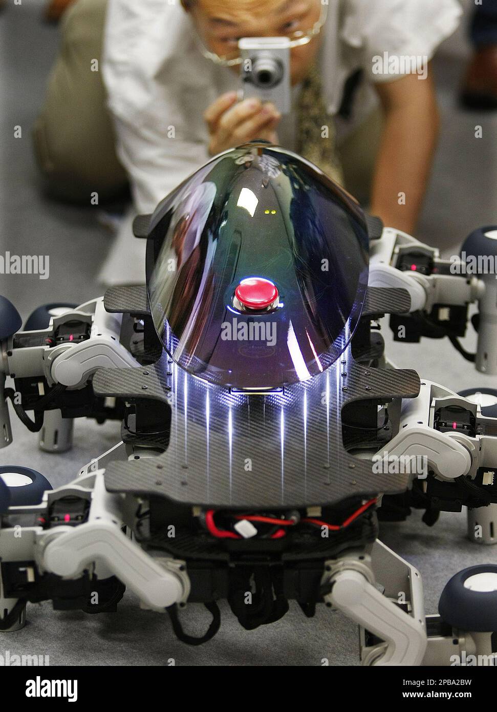 A Japanese journalist takes a photo of a new robot "Halluc II ...