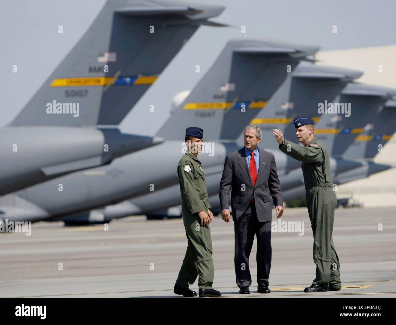 President Bush, center, walks with Col. Mark Bauknight, left, and Col ...