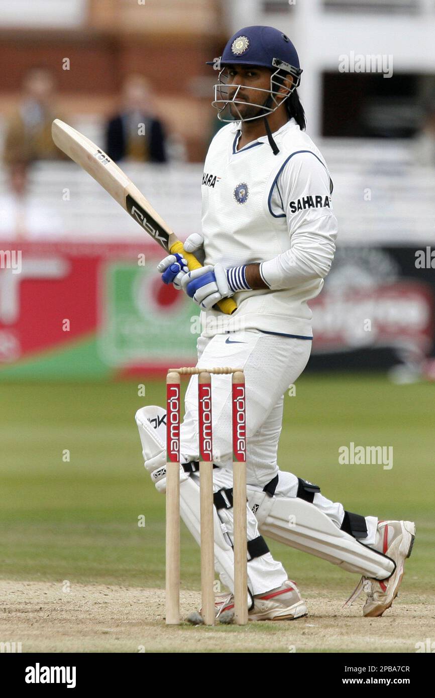 India's Mahendra Dhoni looks around after missing a ball from England's ...