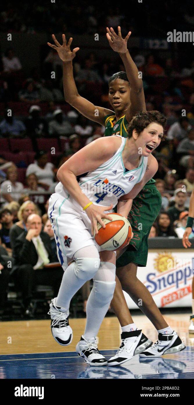New York Liberty's Janel McCarville (4) is blocked by Seattle Storm's ...