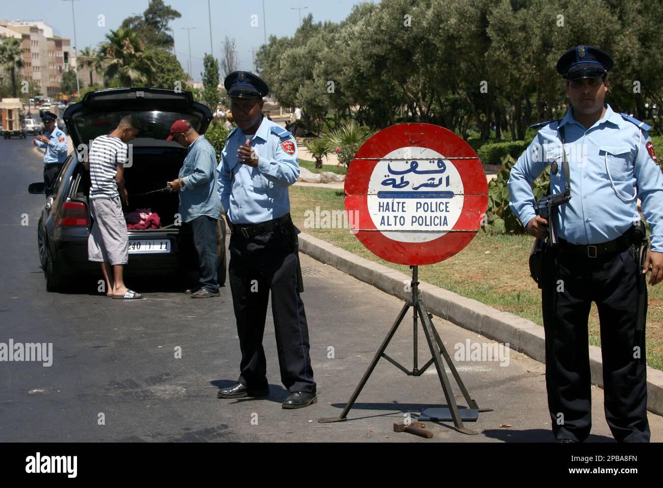 Moroccan police officers stand guard at a checkpoint on King Mohammed ...