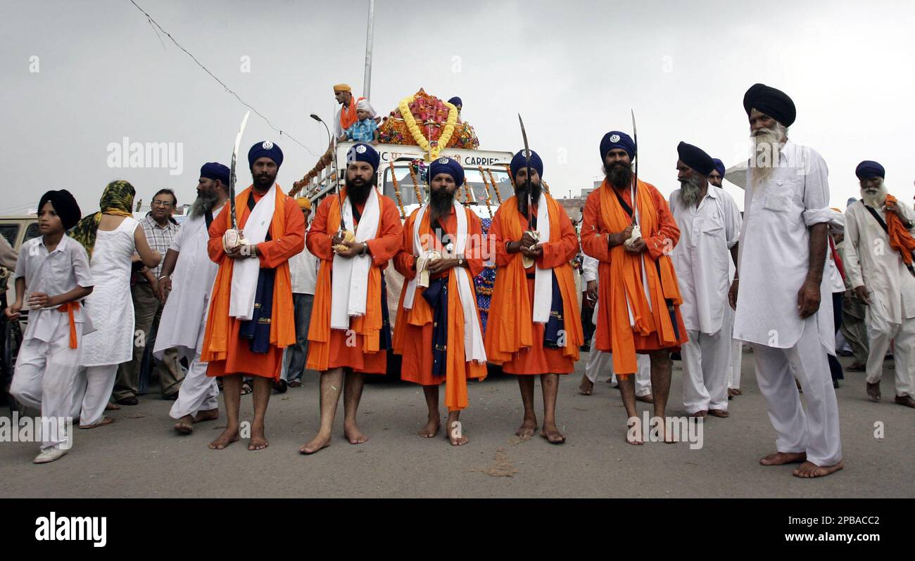 Five baptized Sikhs lead a religious procession outside the Golden ...