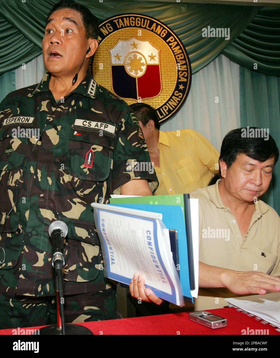 Armed Forces Chief of Staff Gen. Hermogenes Esperon, left, reacts as ...