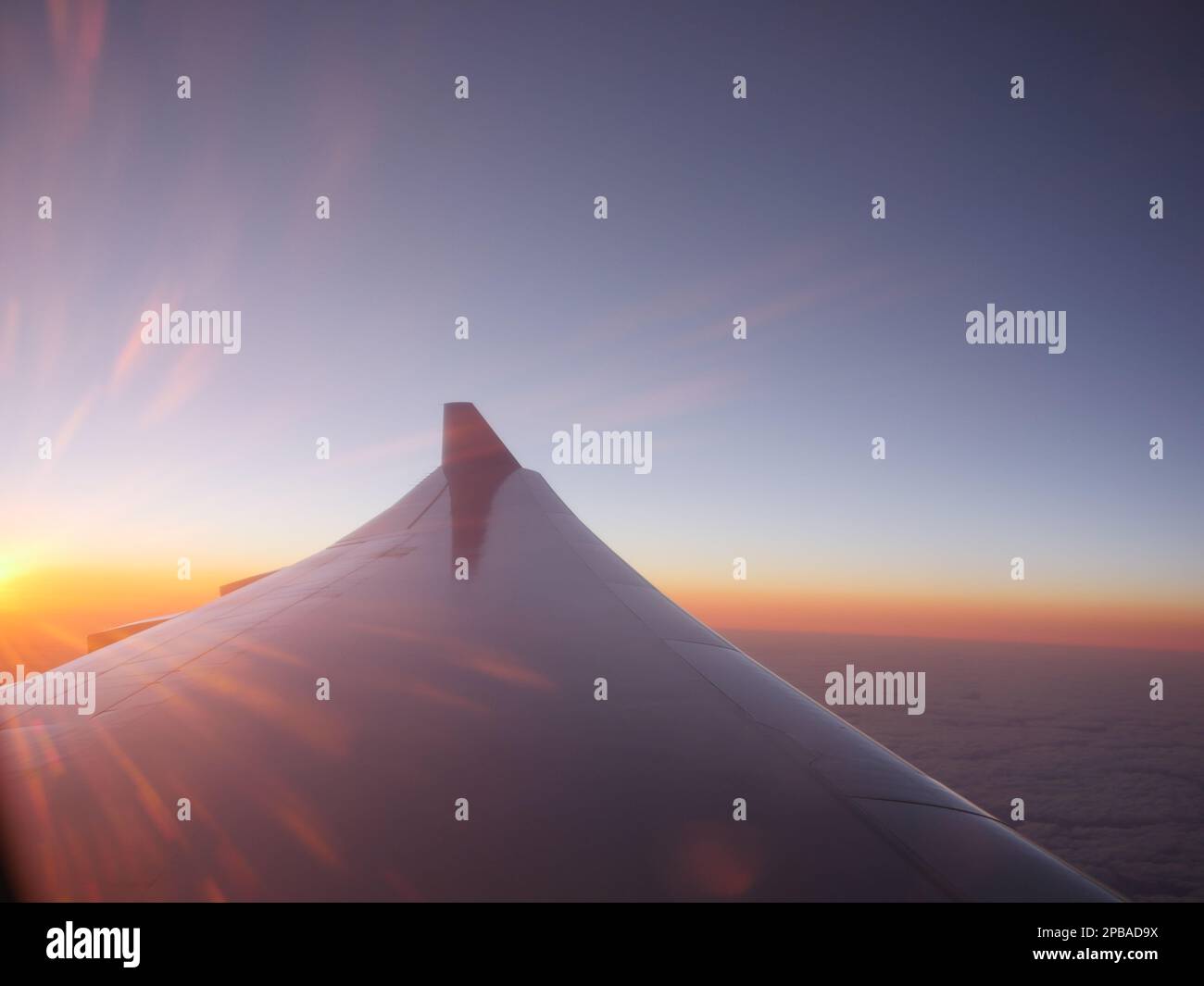 Airplane wing at sunset Stock Photo - Alamy