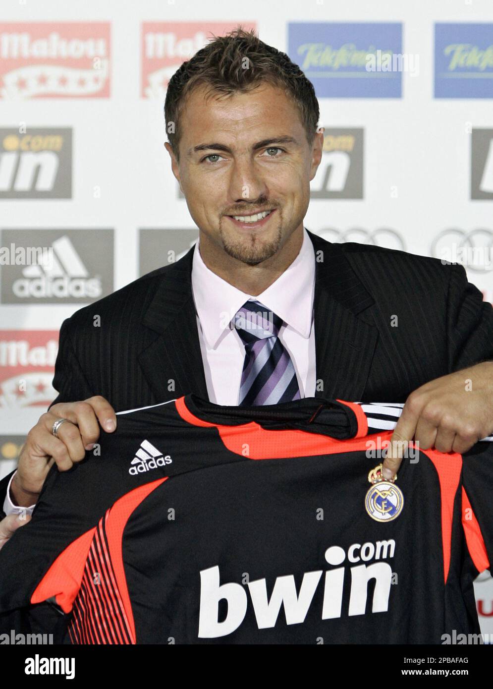 Polish goalkeeper Jerzy Dudek points to the Real Madrid logo on his new ...