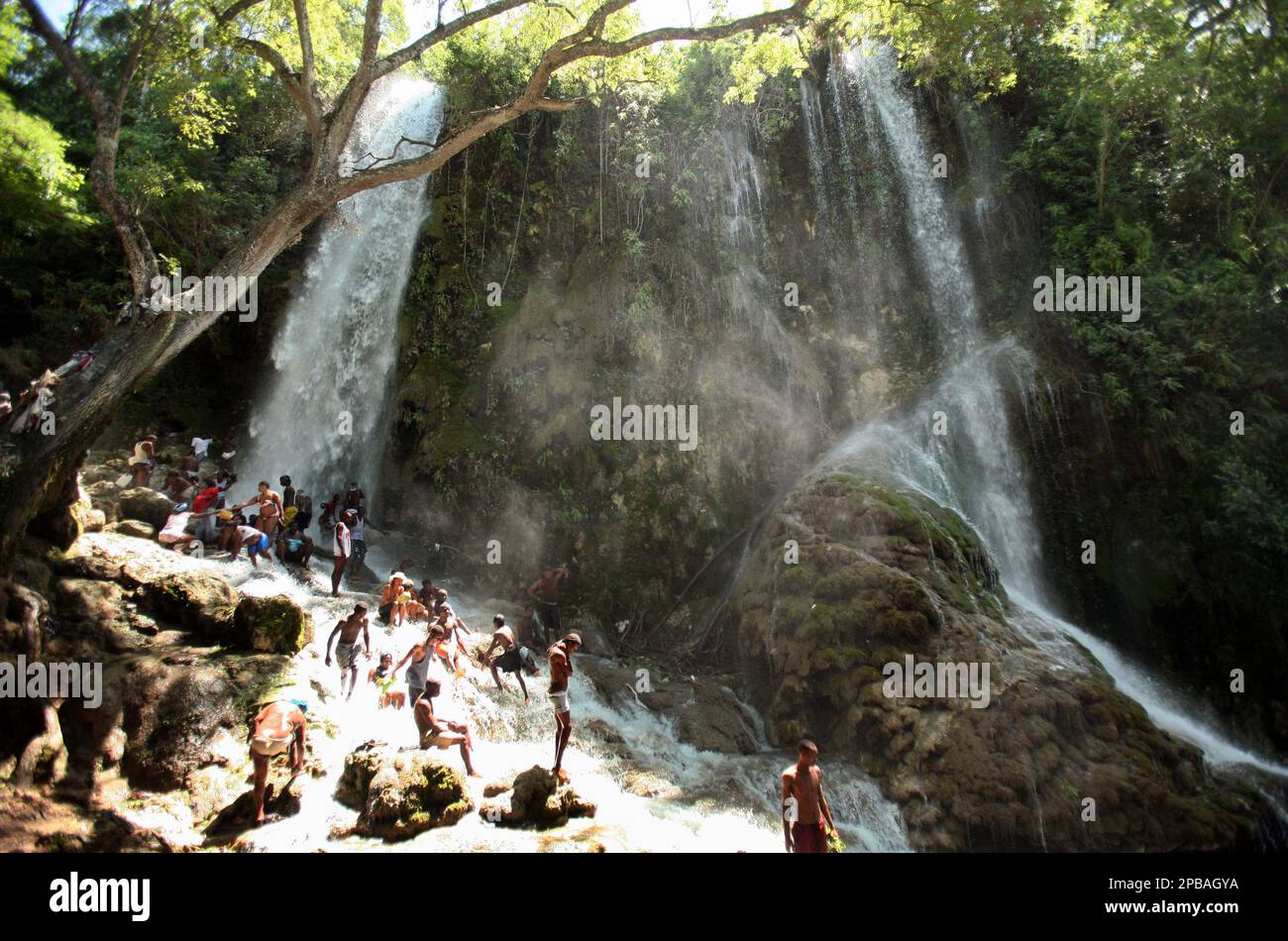 Voodoo believers bathe in a waterfall during a Voodoo pilgrimage where ...