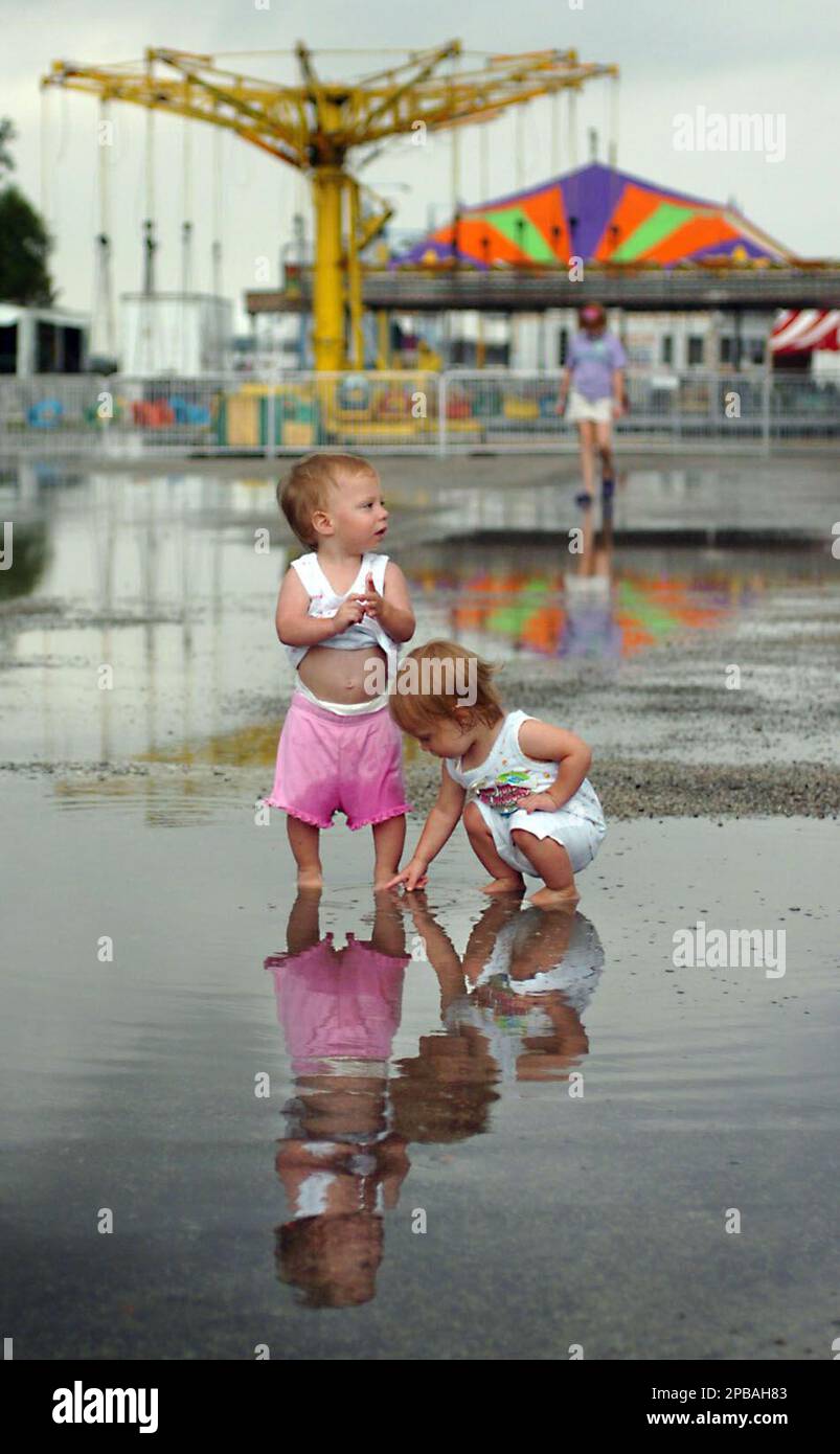 Abigail and Lydia Wyrick, 18-month-old twins from New Haven, Ind., play ...